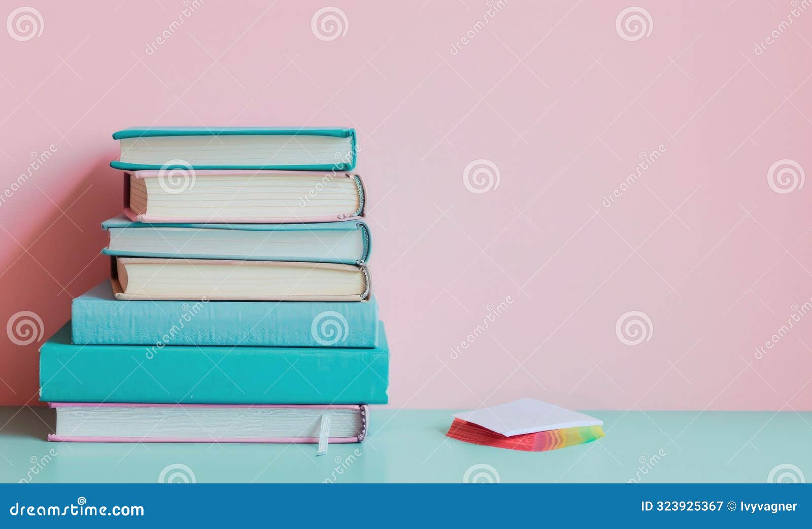 Stack of Books on a White Table with a Pastel Peach Background Stock ...