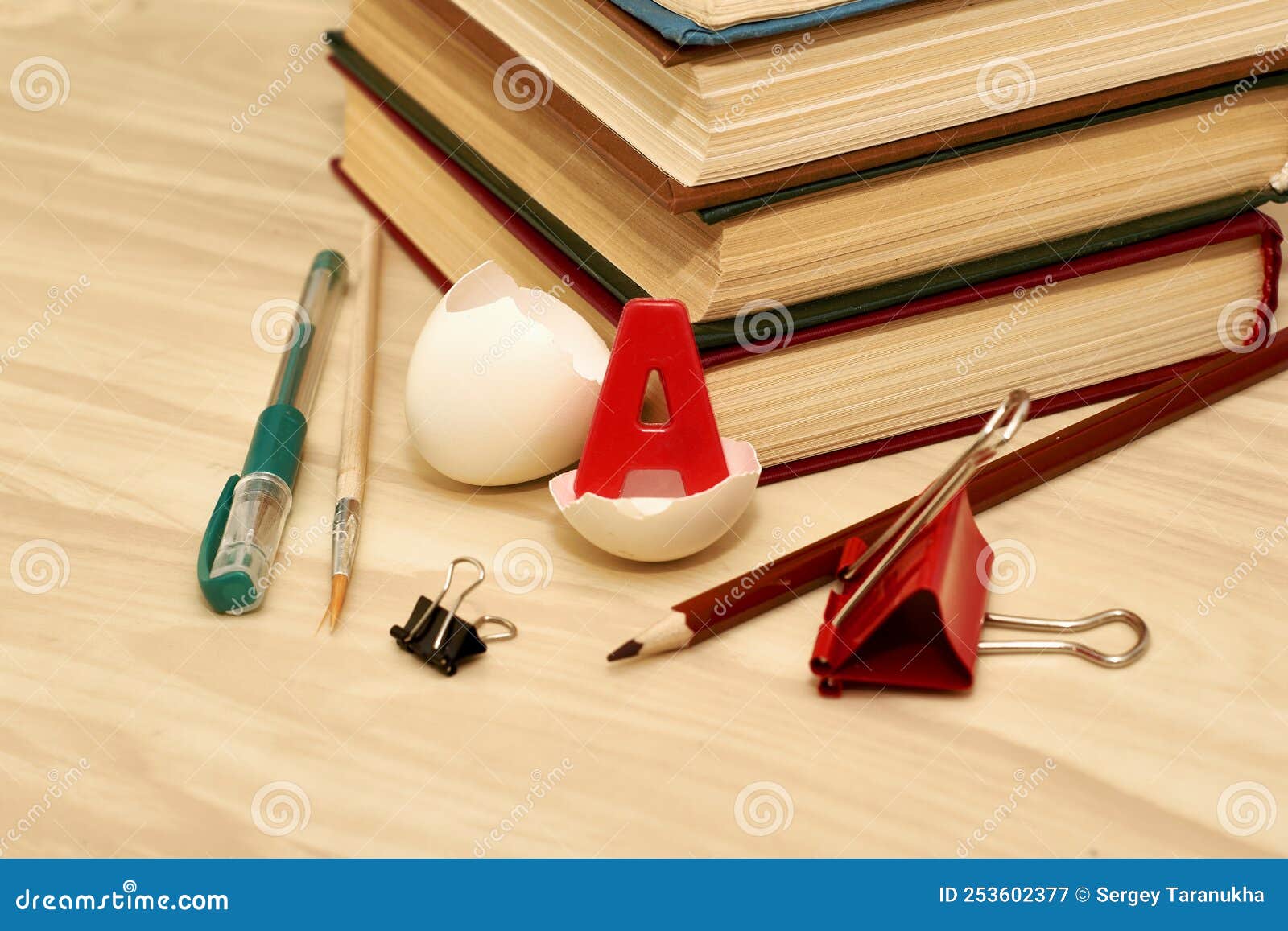 A Stack of Books Writing Materials Stationery Clips and a Split Chicken ...