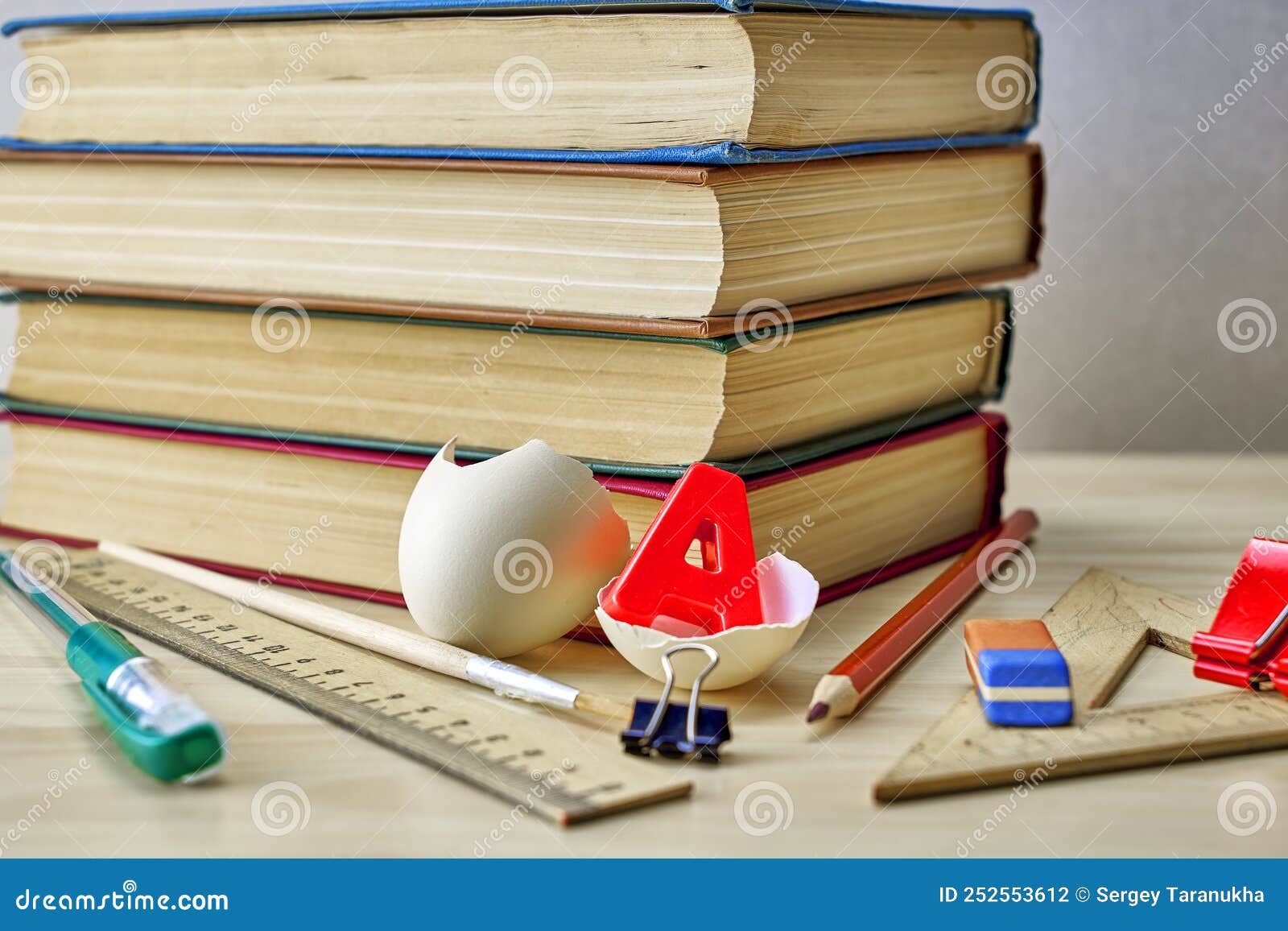 A Stack of Books Writing Materials Stationery Clips and a Split Chicken ...