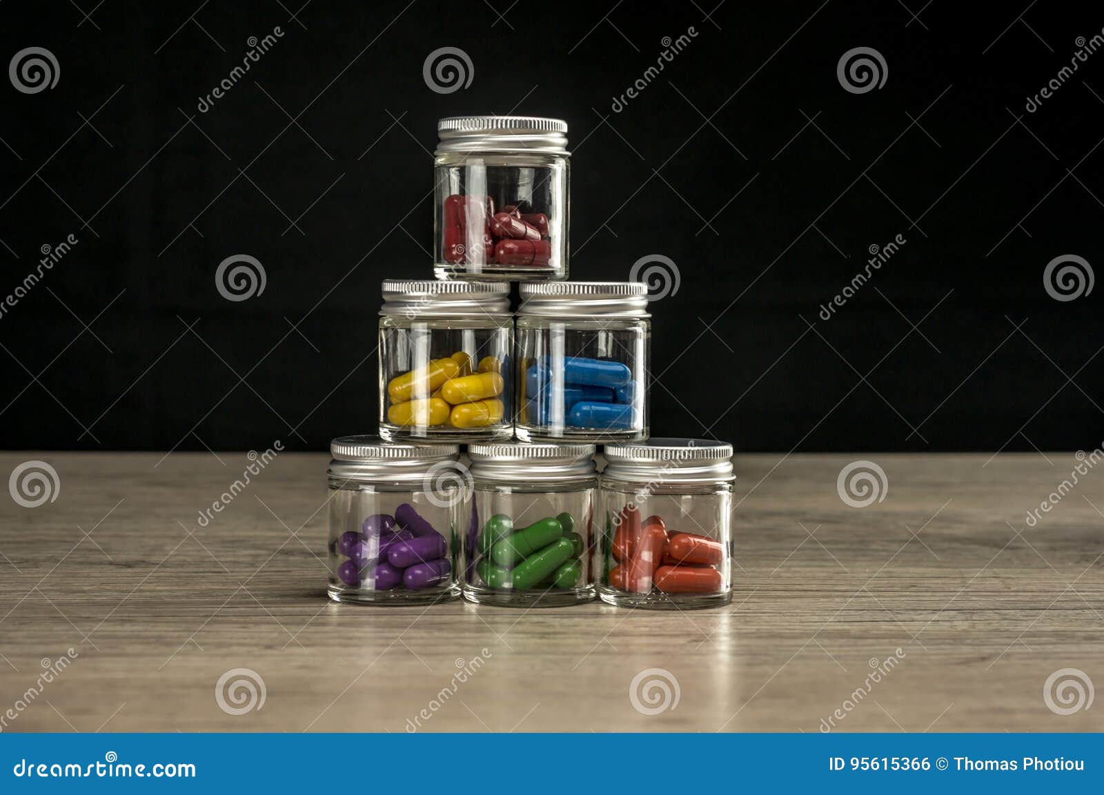 Stack of Bottles Filled with Colored Prescription Pills Stock Photo ...