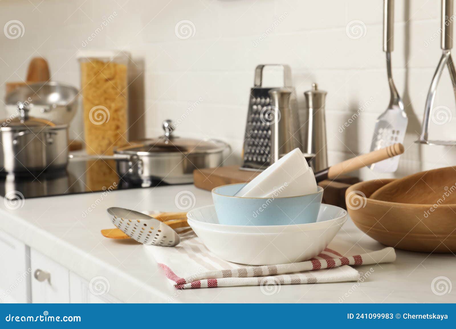 Stack of Bowls and Different Cooking Utensils on Kitchen Counter Stock ...