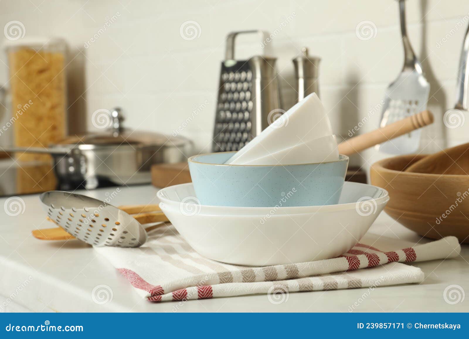 Stack of Bowls and Different Cooking Utensils on Kitchen Counter Stock ...