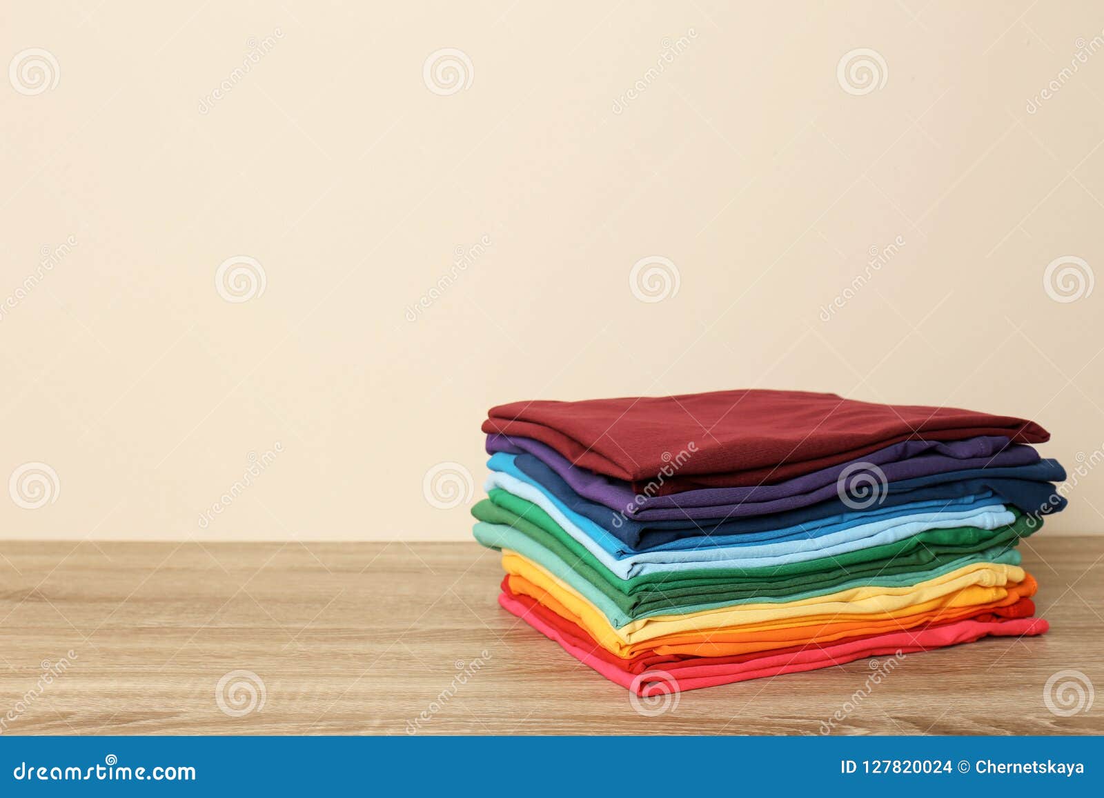 Stack of Bright Folded Clothes on Table Stock Photo - Image of choice ...