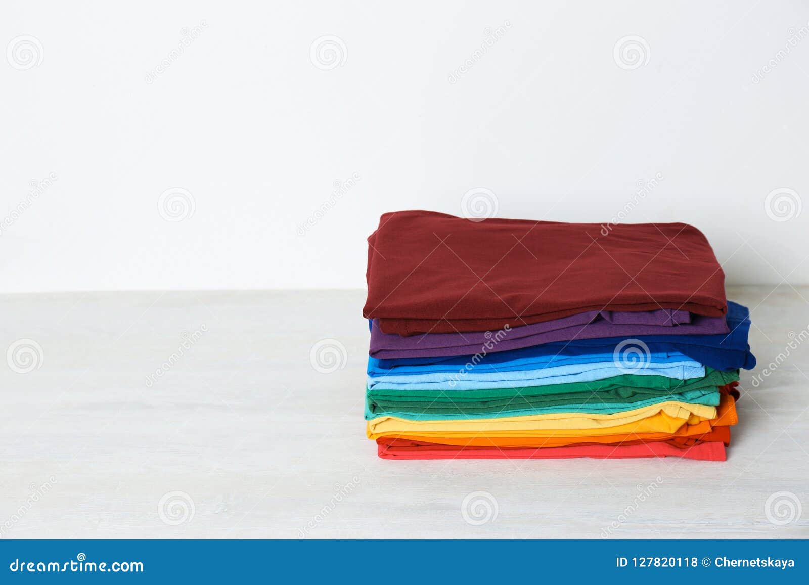 Stack of Bright Folded Clothes on Table Stock Photo - Image of clothes ...