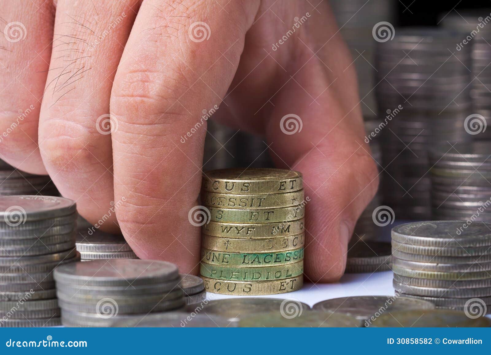 Stack of British Pound Coins with a Male Hand Stock Photo - Image of ...