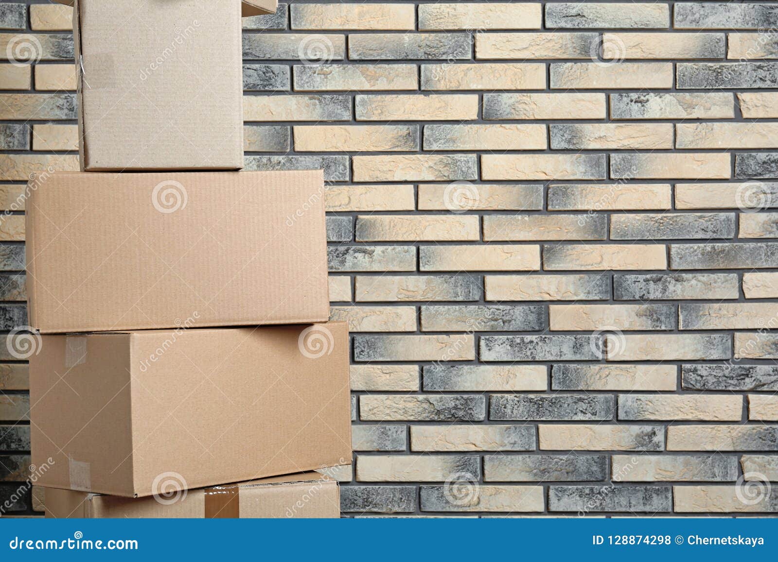 Stack of Cardboard Boxes Near Brick Wall Stock Photo - Image of freight ...