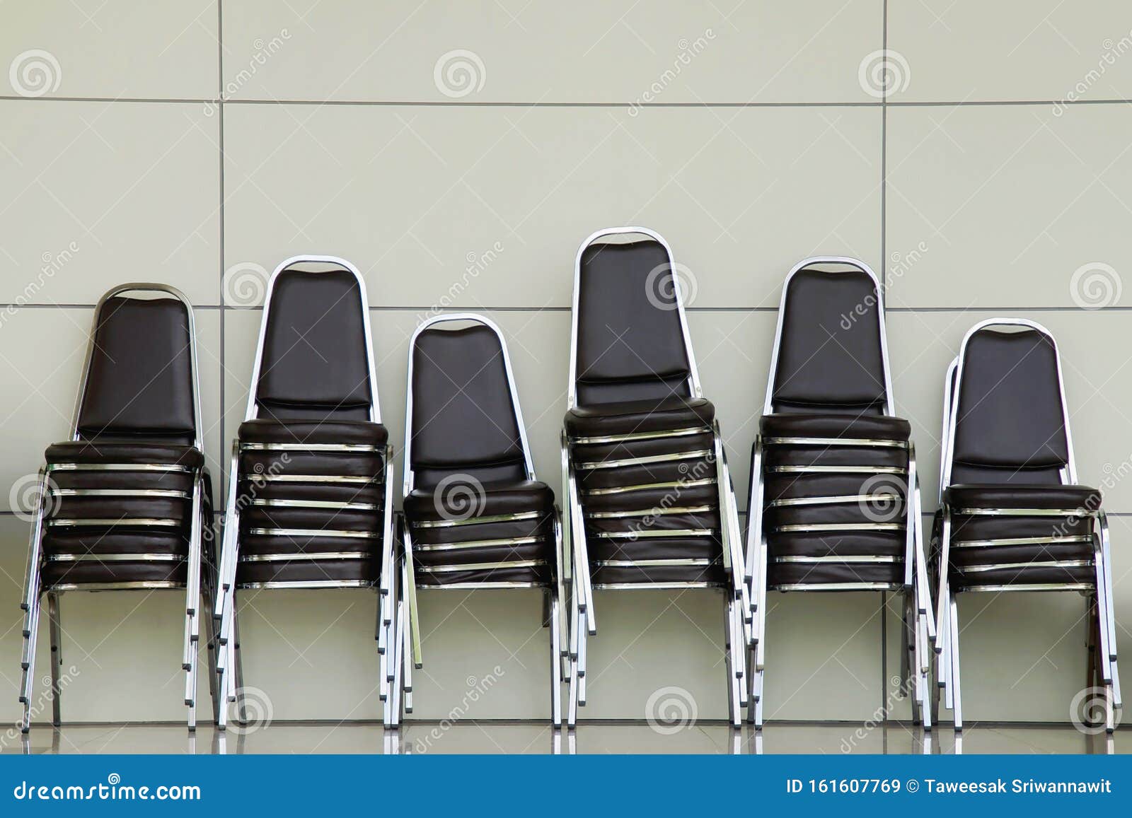 Stack of Chairs Against White Wall Background Stock Image - Image of ...