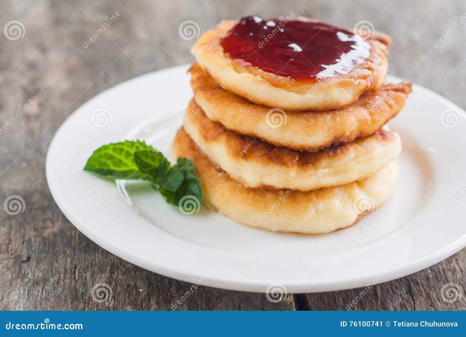 Stack of Cheesecakes with Jam on a White Plate on a Dark Wooden Stock ...