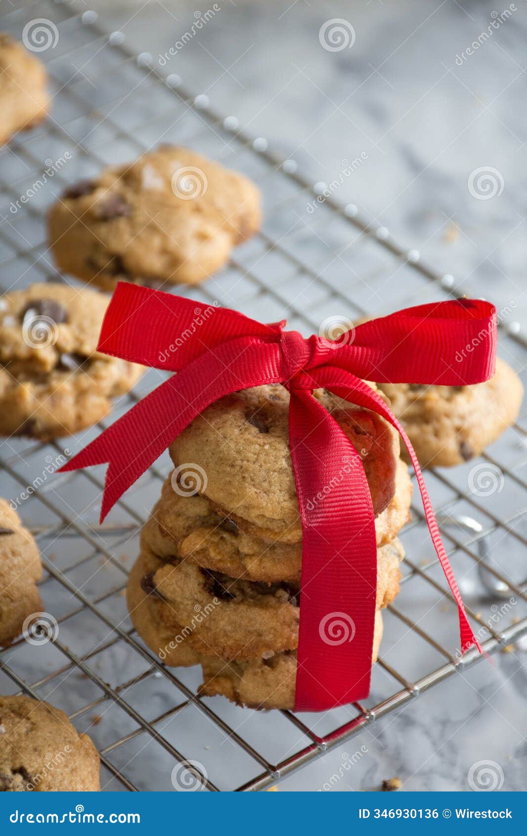 Stack of Chocolate Chip Cookies Tied with a Red Ribbon on Cooling Rack ...