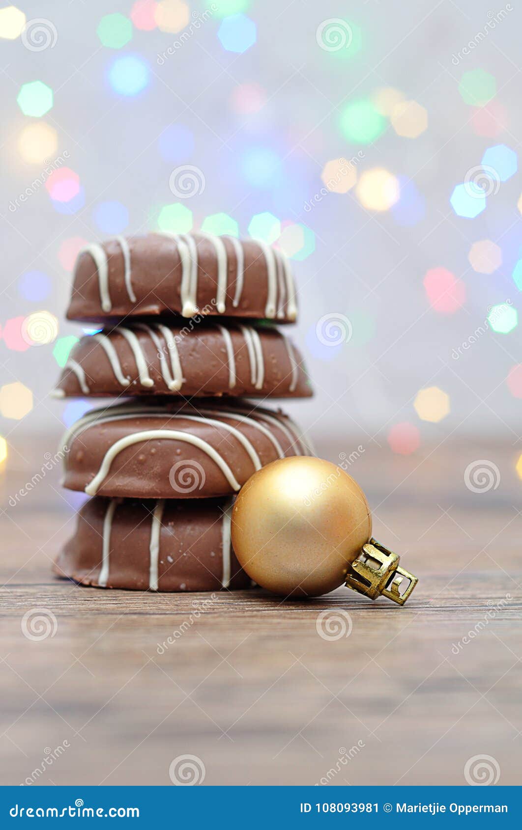 A Stack of Chocolate Covered Biscuits and a Golden Babble Stock Image ...