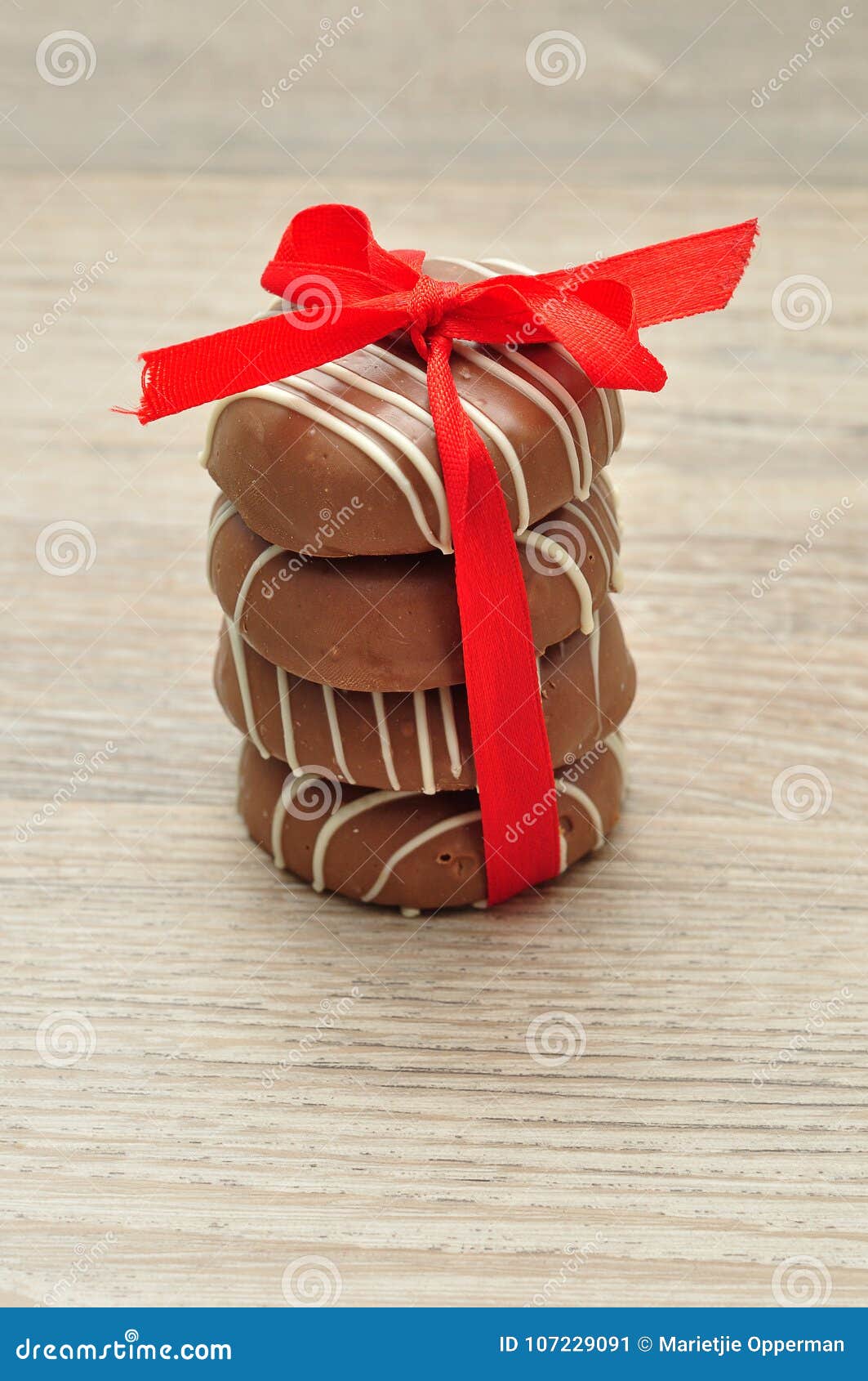 A Stack of Chocolate Covered Biscuits Tied with a Red Ribbon Stock ...