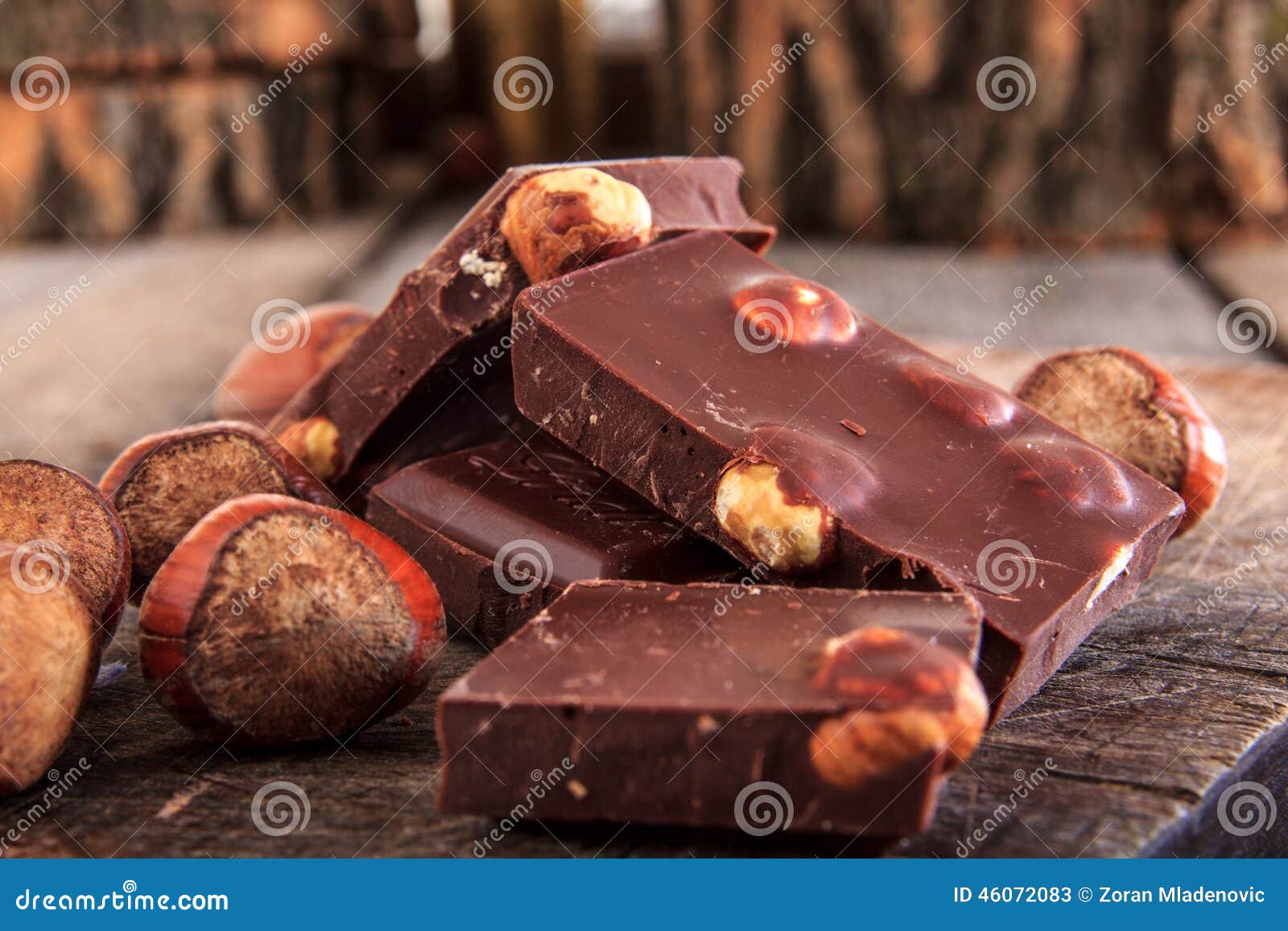 Stack of Chocolate Pieces with Hazelnuts on Wooden Table Stock Image ...