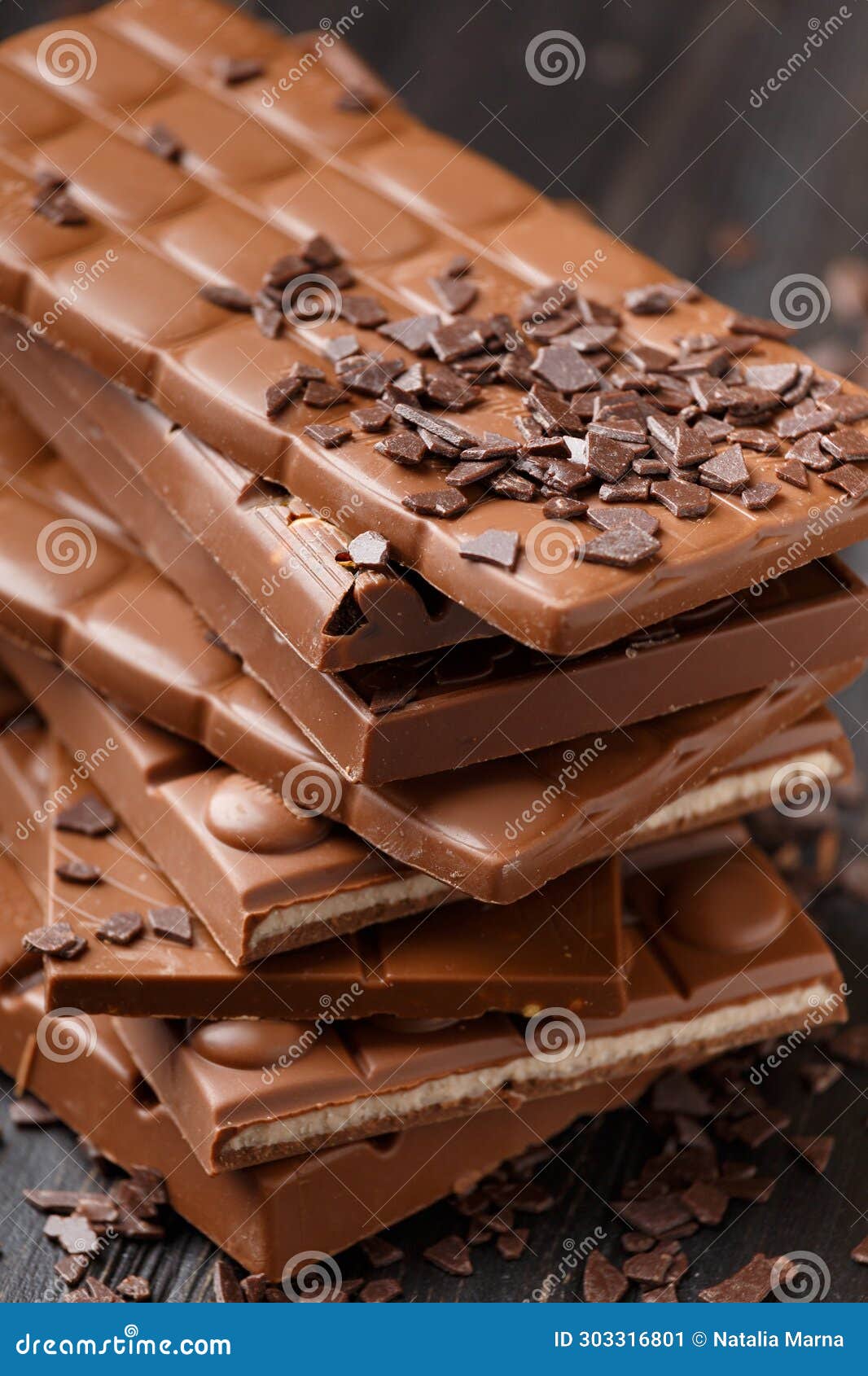 Stack of Chocolate and Scattered Chocolate Chips on Wooden Background ...