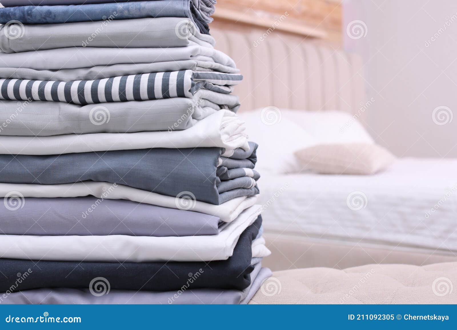 Stack of Clean Bed Linens in Bedroom. Space for Text Stock Image ...
