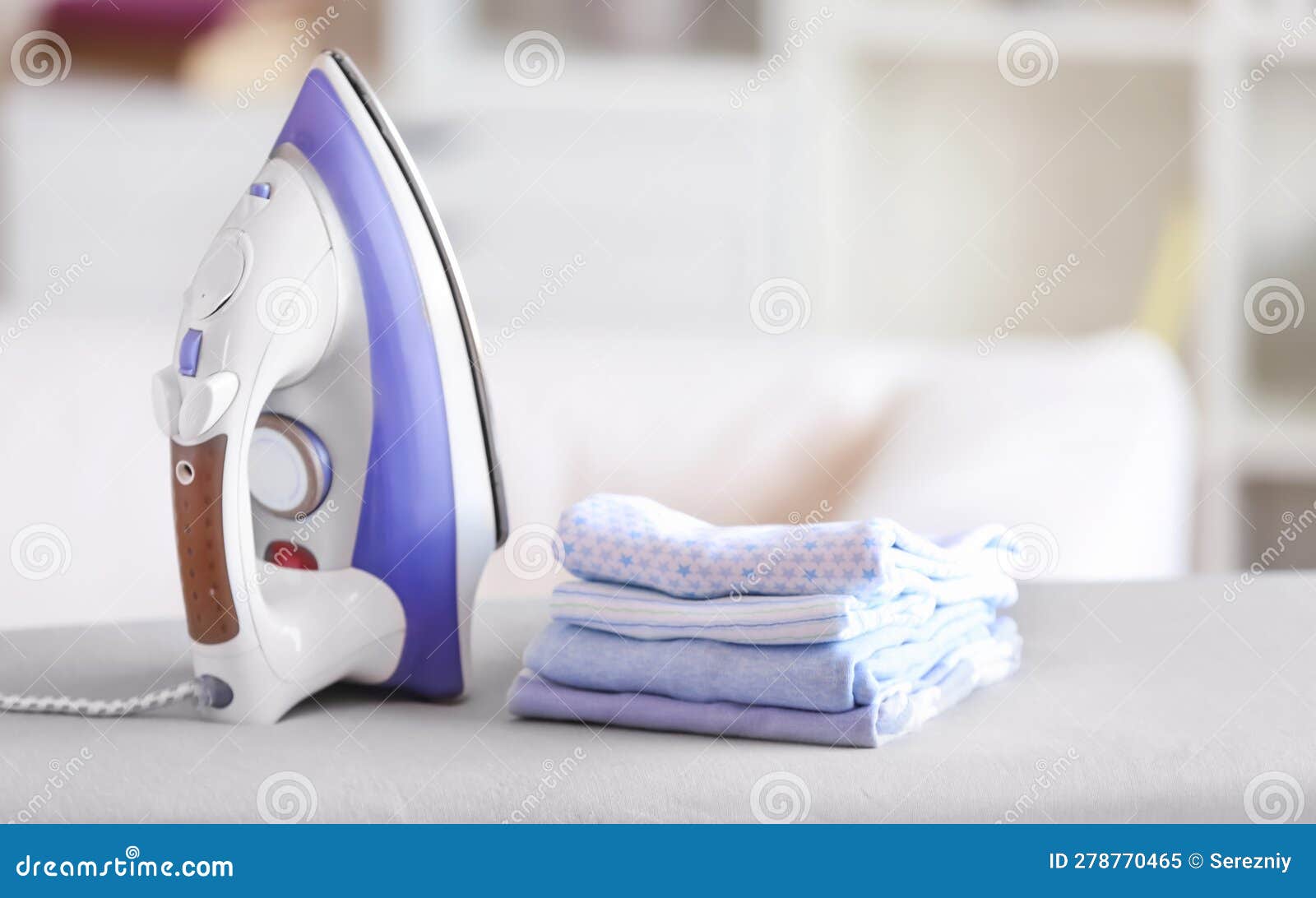 Stack of Clean Clothes on Ironing Board at Home Stock Image - Image of ...