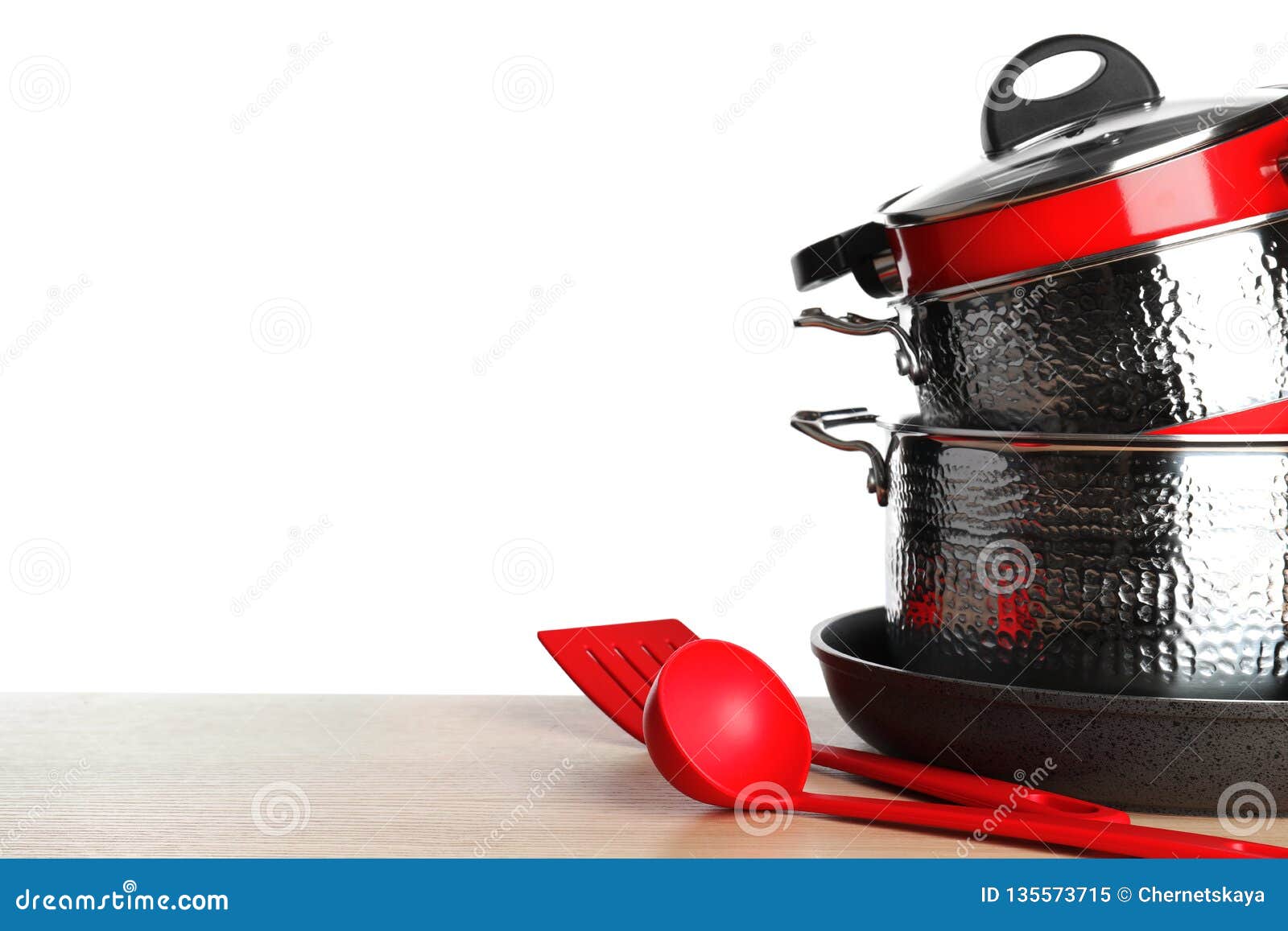 Stack of Clean Cookware and Utensils on Table Against White Background ...
