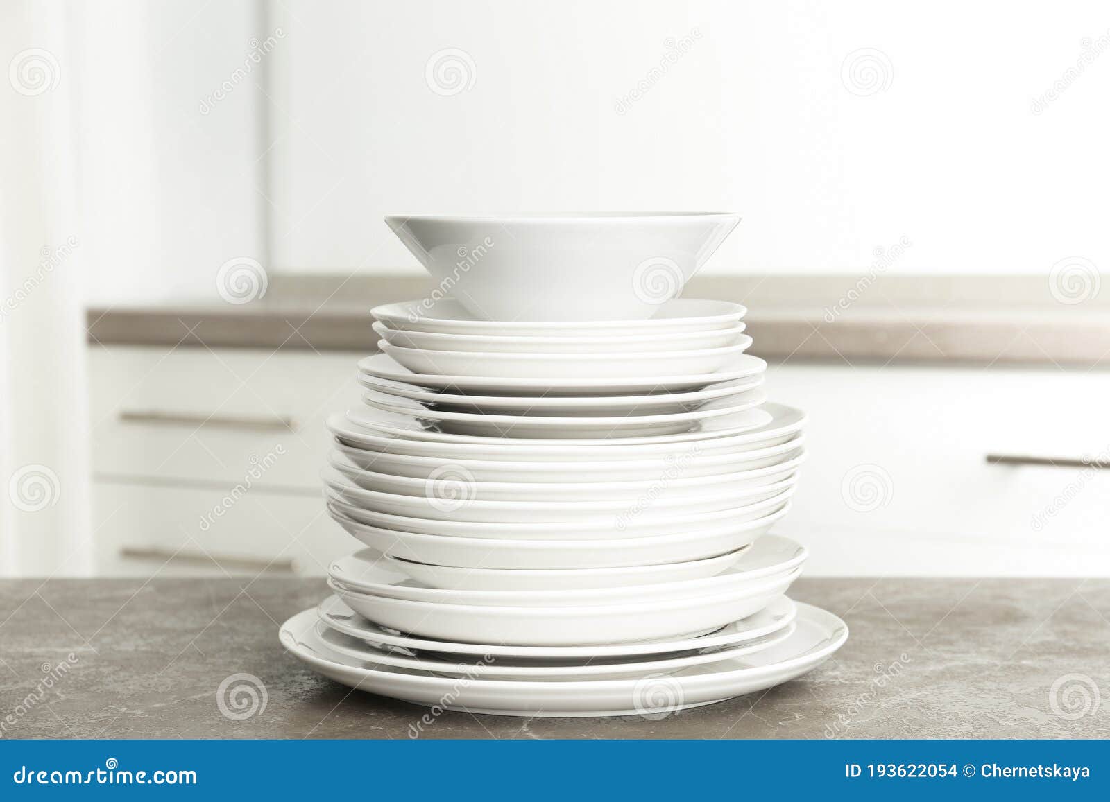 Stack of Clean Plates on Table in Kitchen Stock Photo - Image of group ...