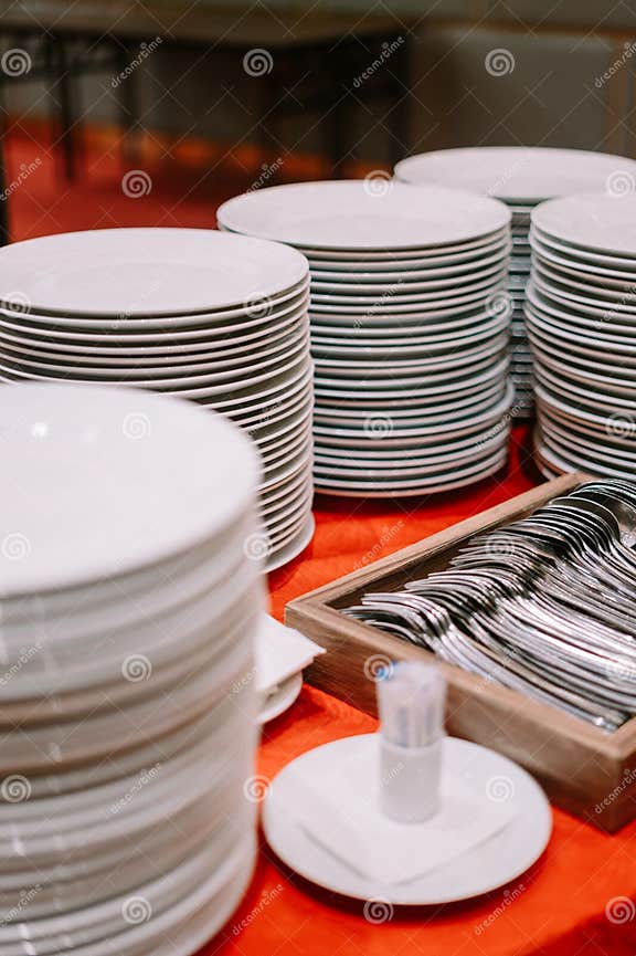 A Stack of Clean Plates and Spoons Neatly Arranged on a Buffet Table ...