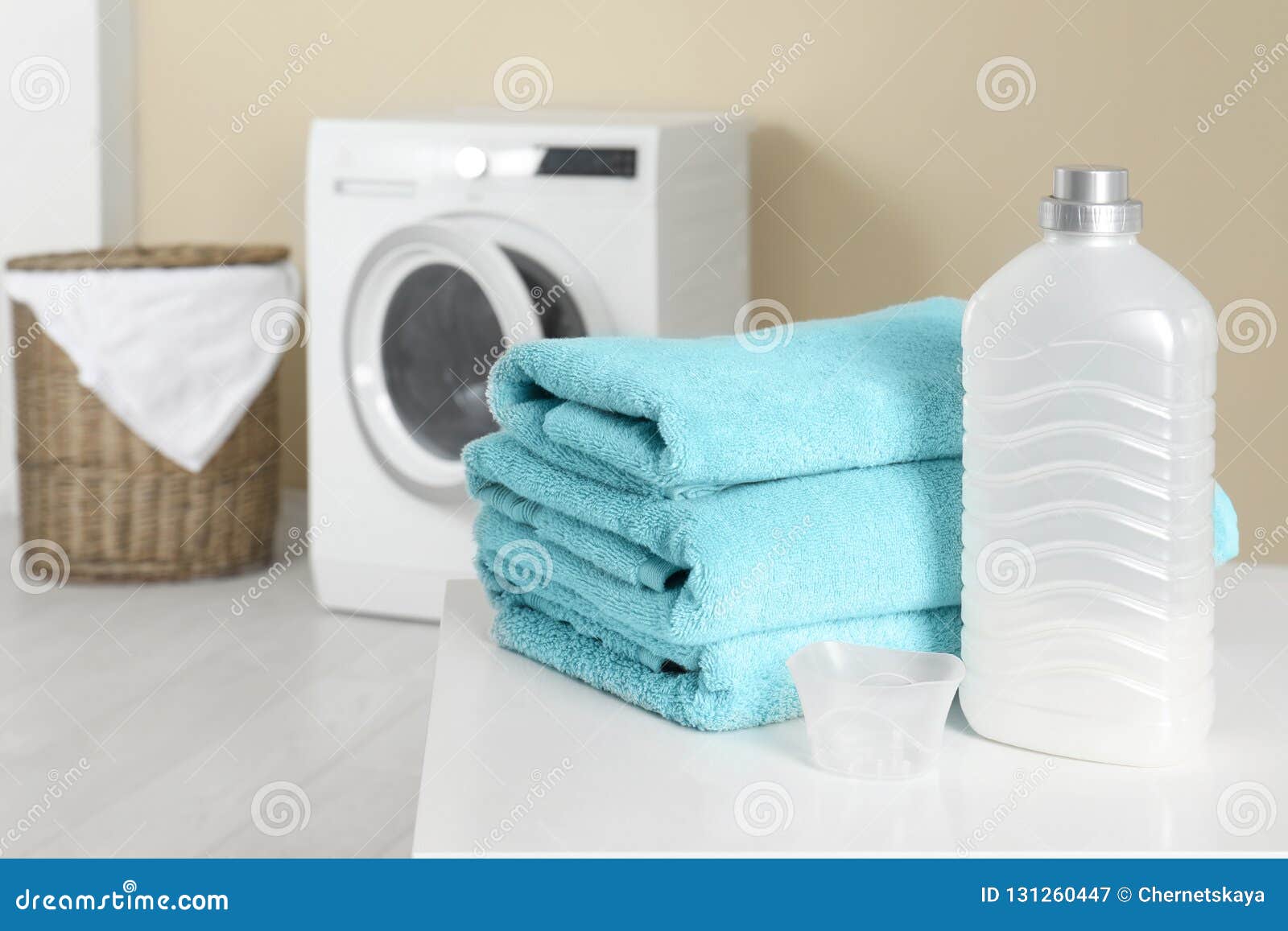 Stack of Clean Towels and Detergent on Table Stock Image - Image of ...