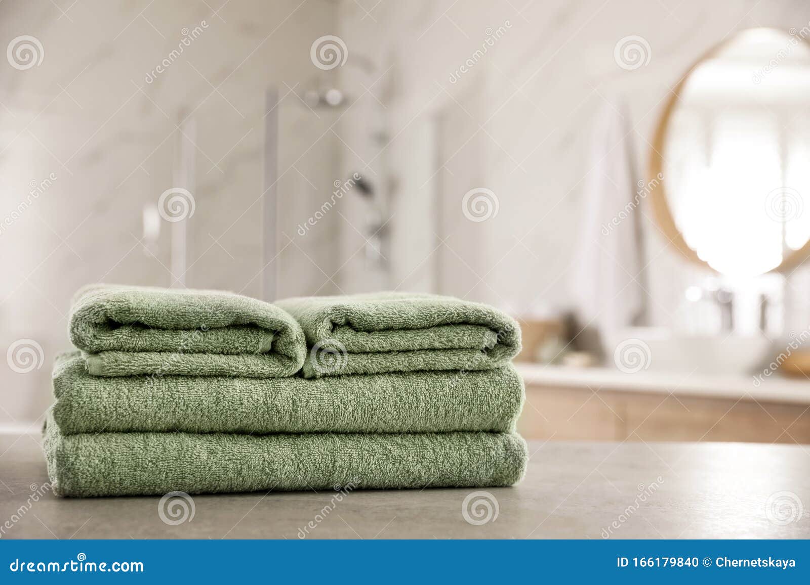 Stack of Clean Towels on Table Stock Photo - Image of green, bath ...