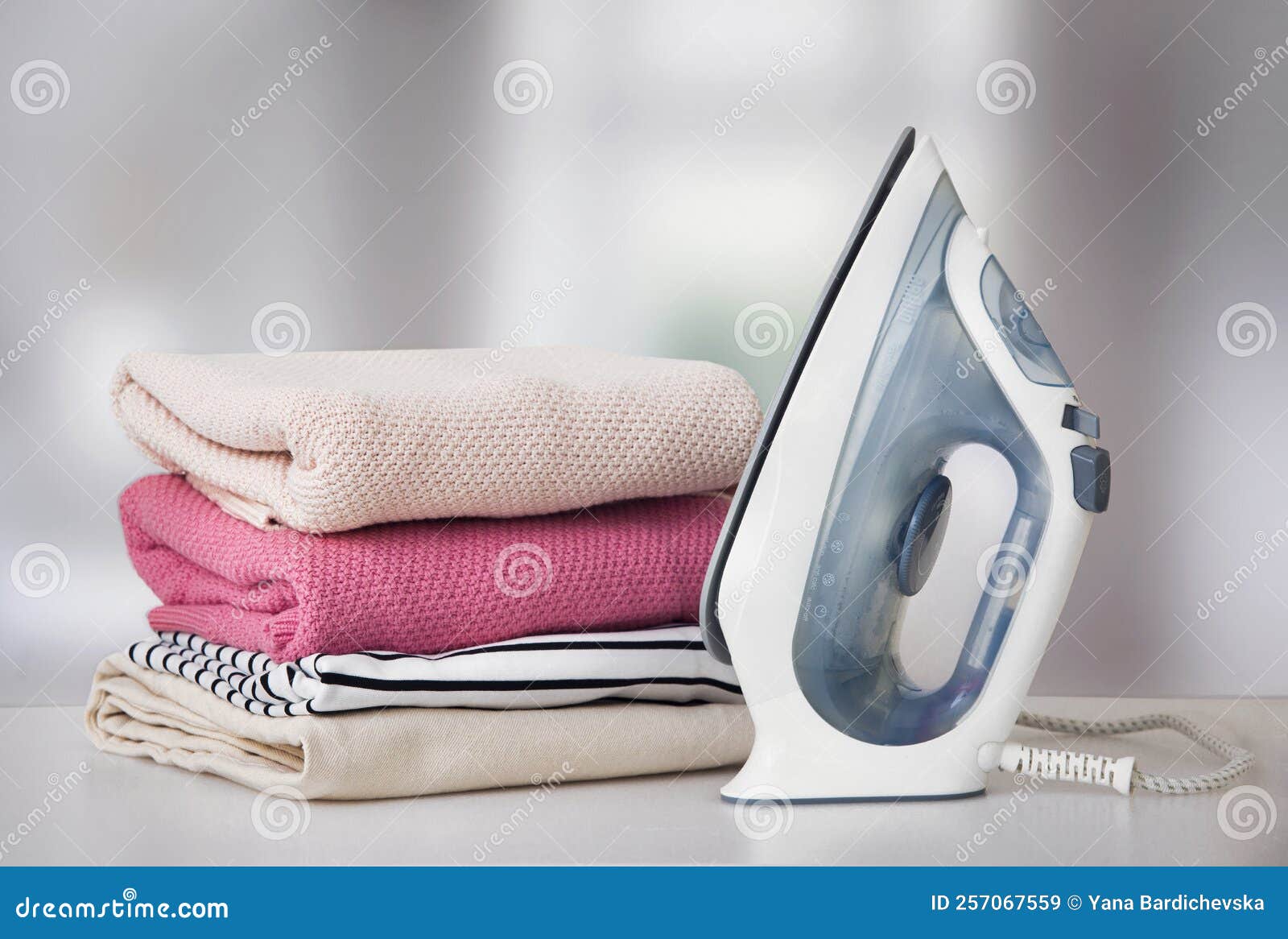 Stack of Clothes and Iron on Table.Housework Stock Image - Image of ...