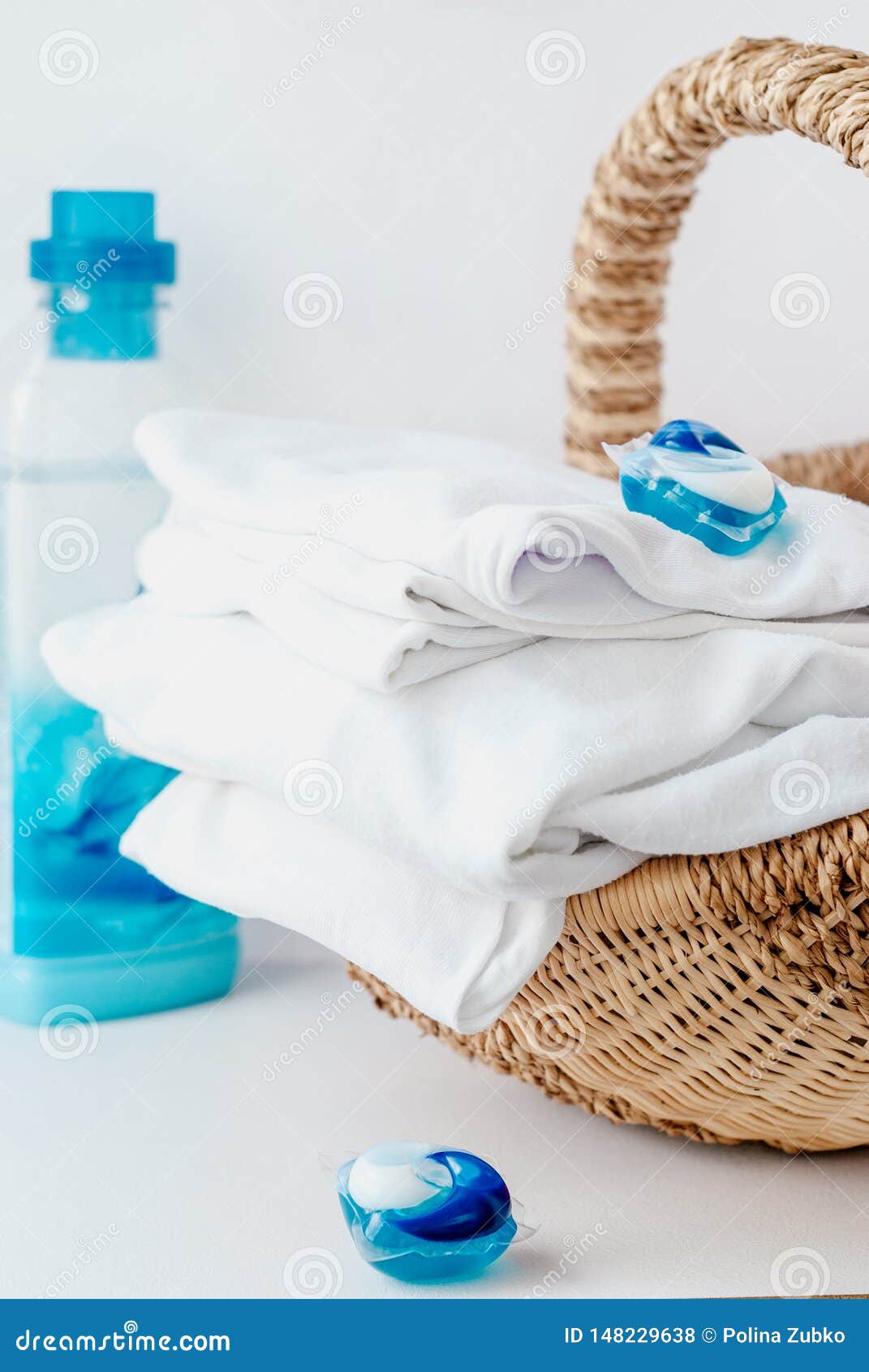 Stack of Clothes and Laundry Pods in a Basket at Home Stock Photo ...