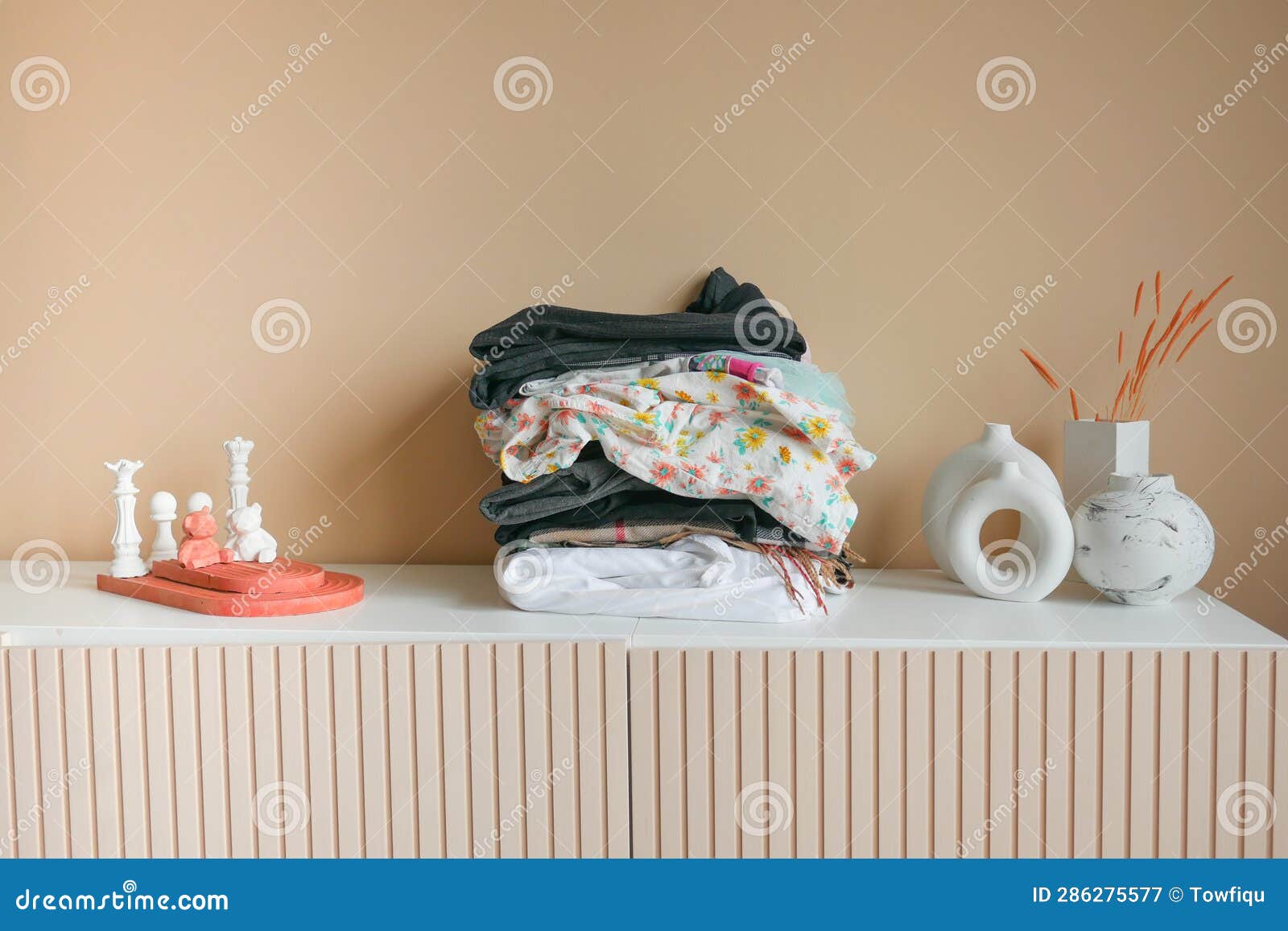 Stack of Clothes on Table Indoor. Stock Image - Image of folded ...