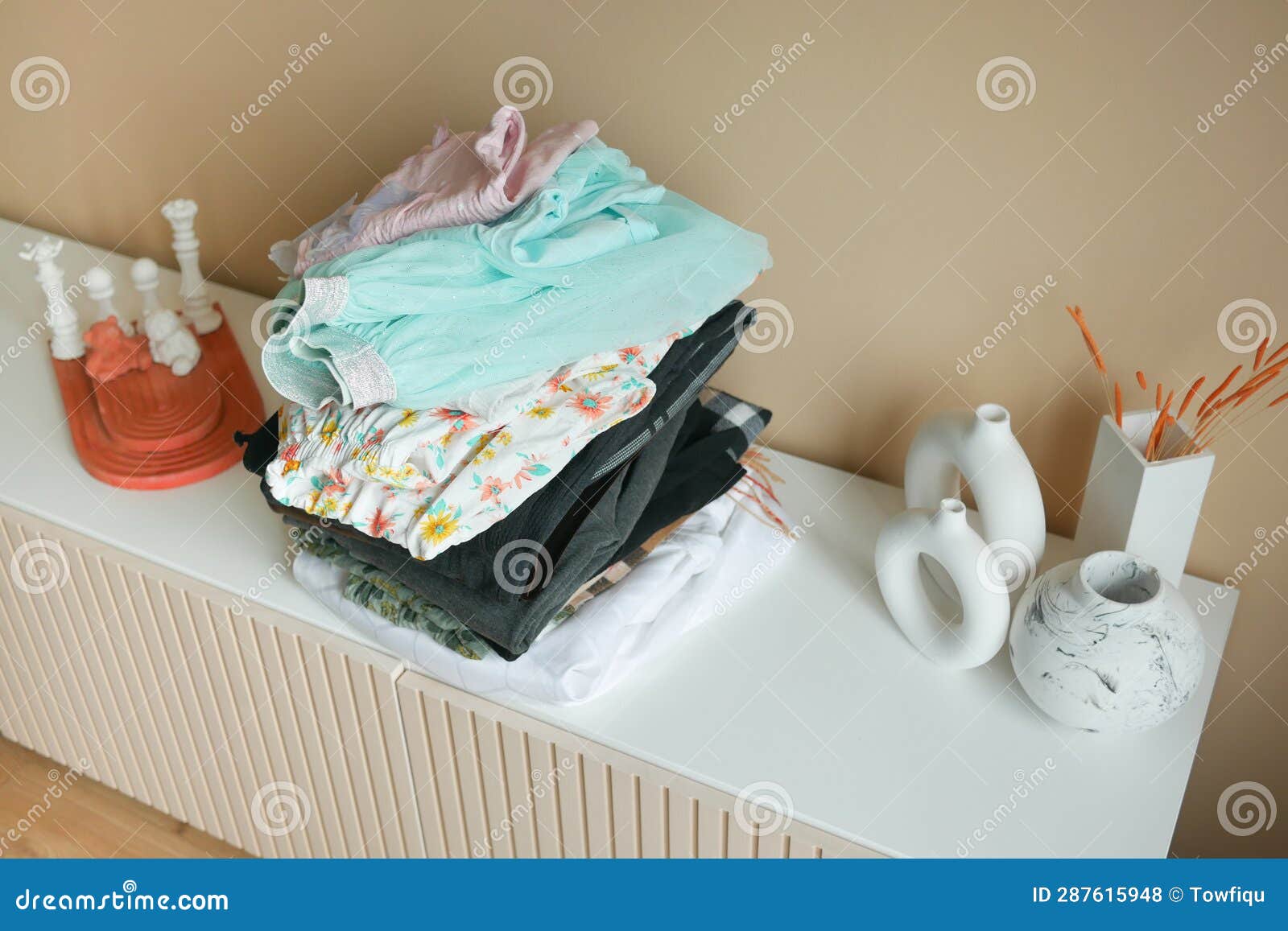 Stack of Clothes on Table Indoor. Stock Photo - Image of space, stacked ...