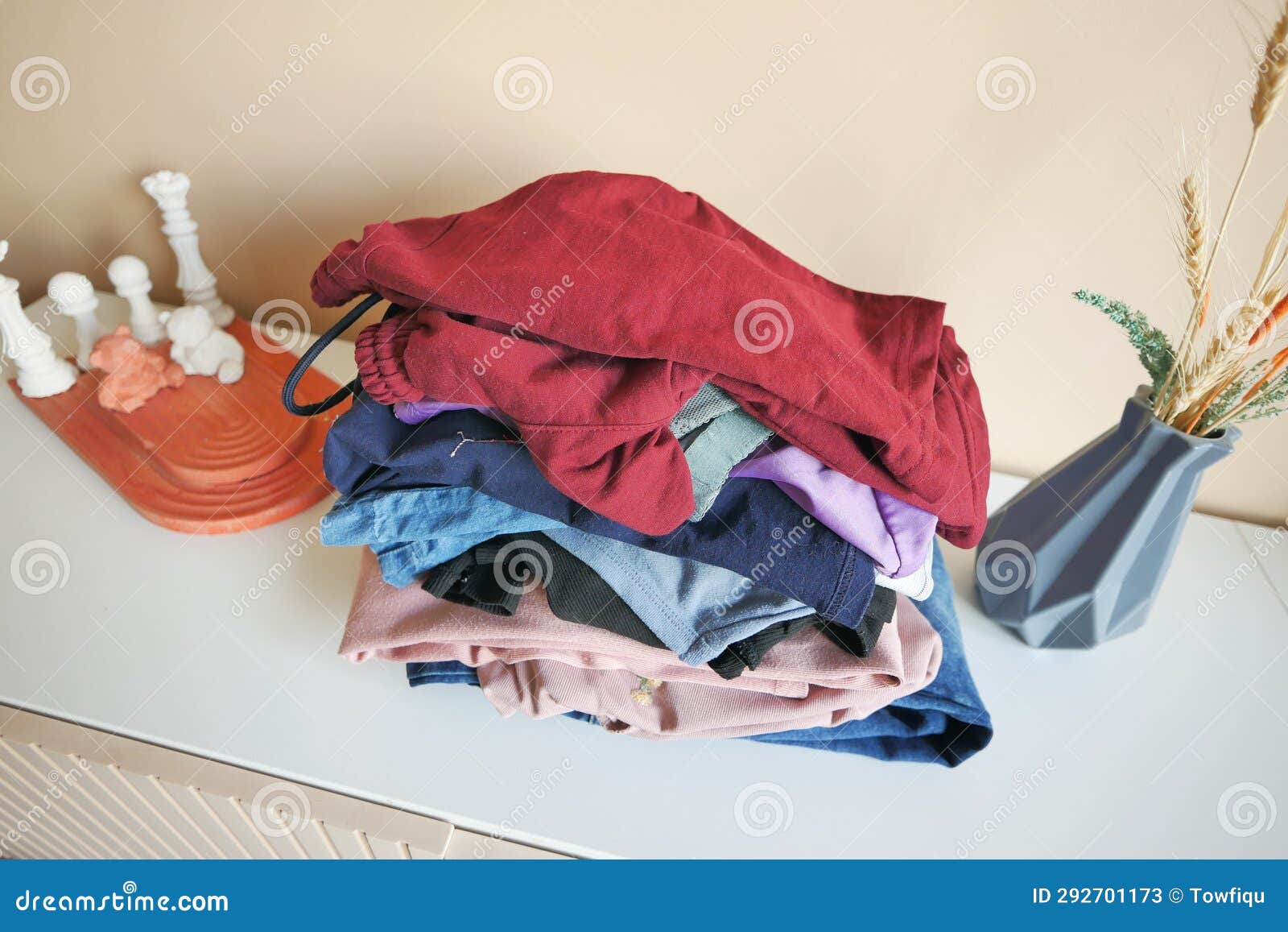 Stack of Clothes on Table Indoor. Stock Image - Image of folded, store ...
