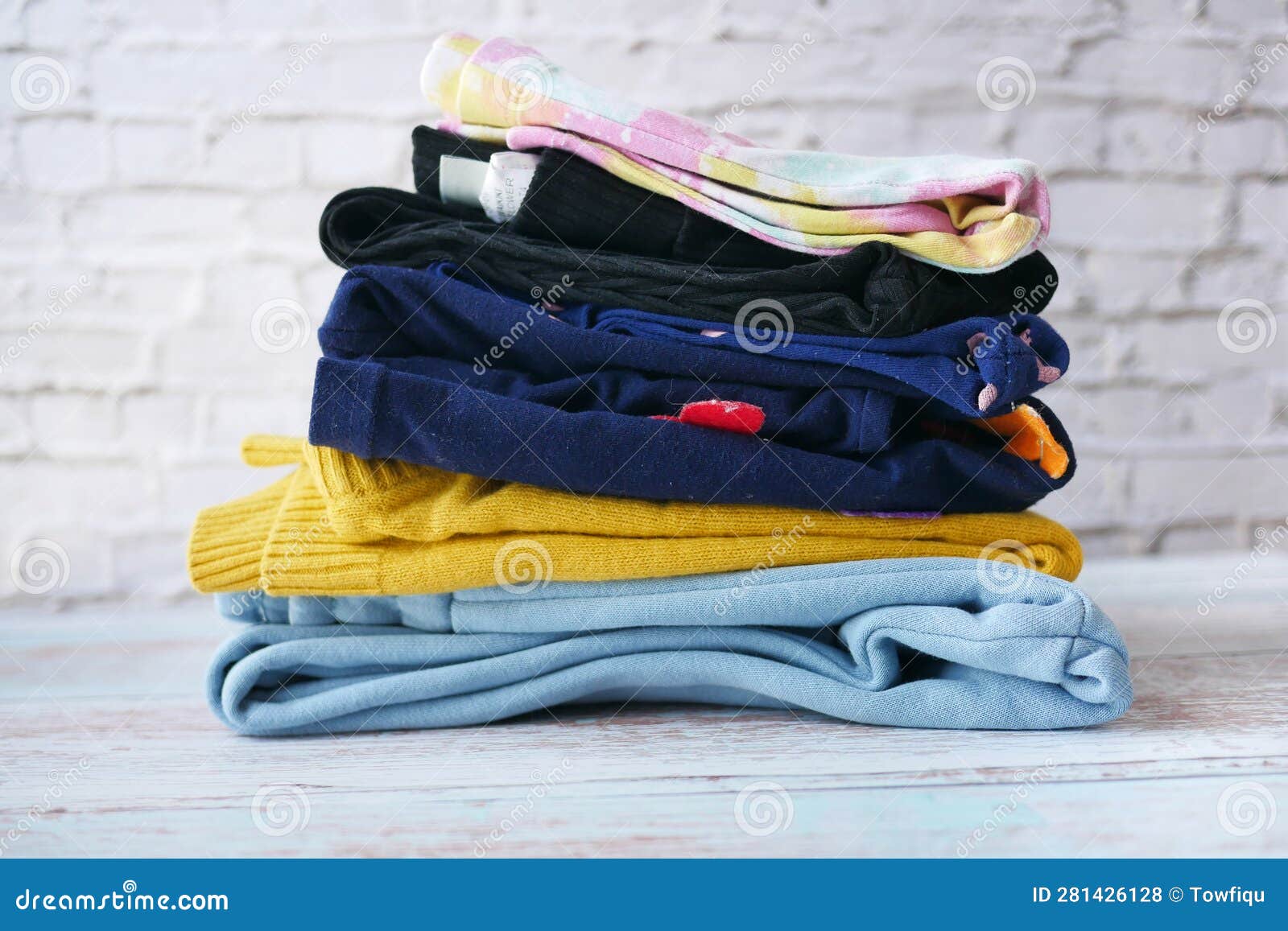 Stack of Clothes on Table Indoor. Stock Photo - Image of space ...