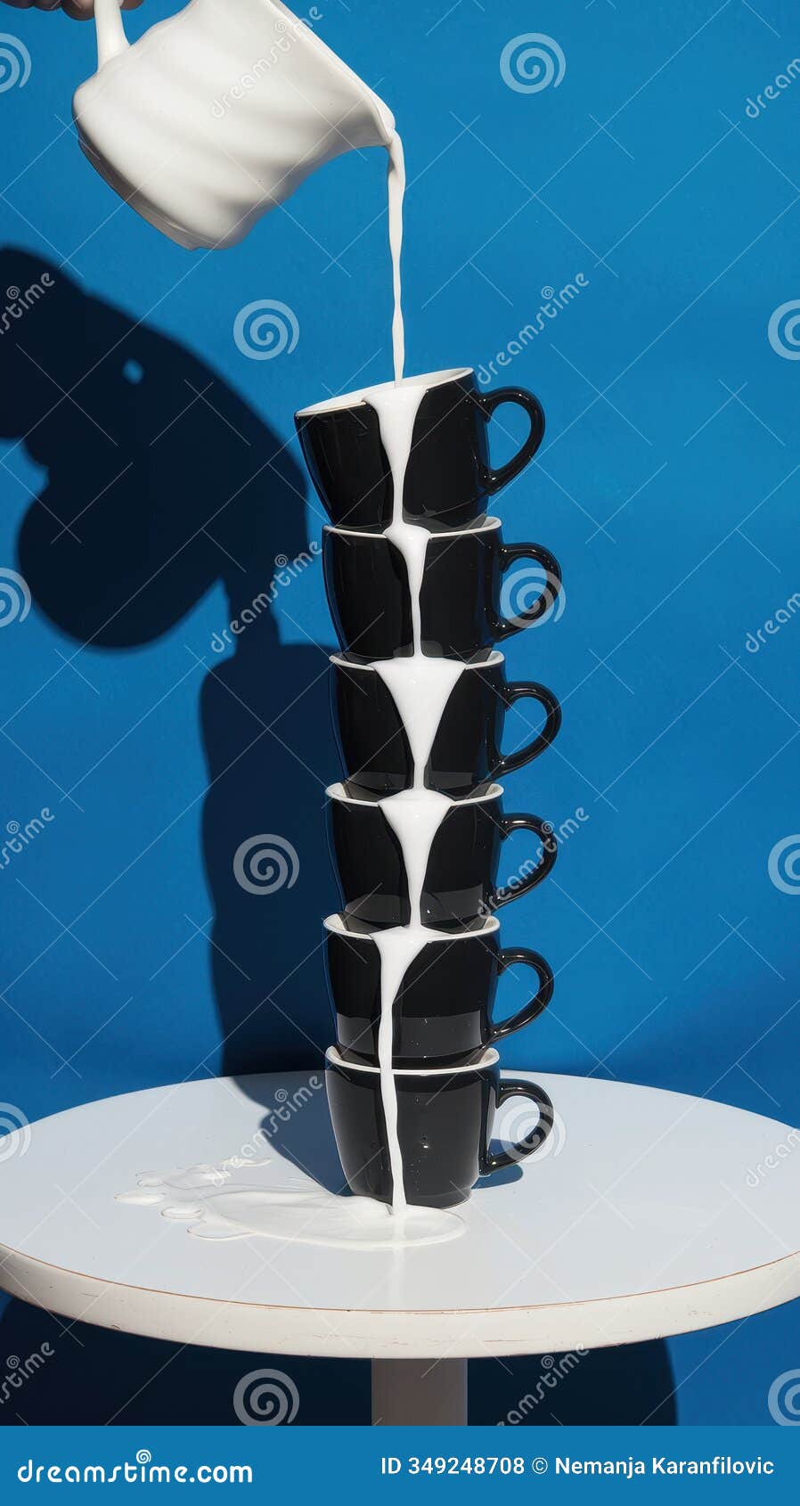 Stack of Coffee Cups with Milk Pouring Down from Above Stock ...