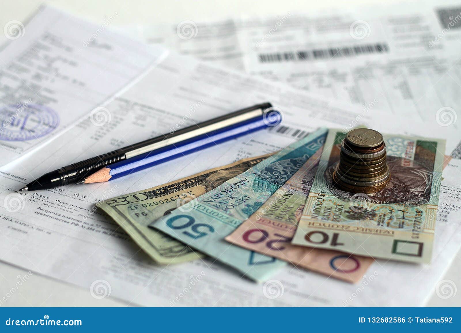 Stack of Coins with Banknotes and Pens on Payment Papers Stock Photo ...