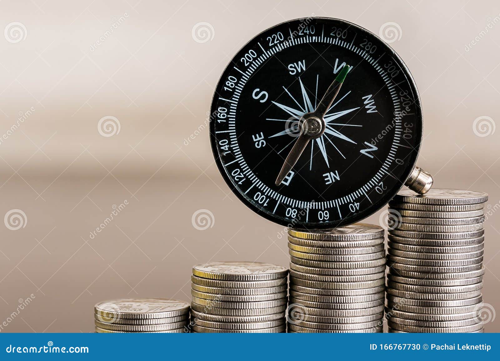 Stack of Coins with Compass on Wood Table Stock Photo - Image of growth ...
