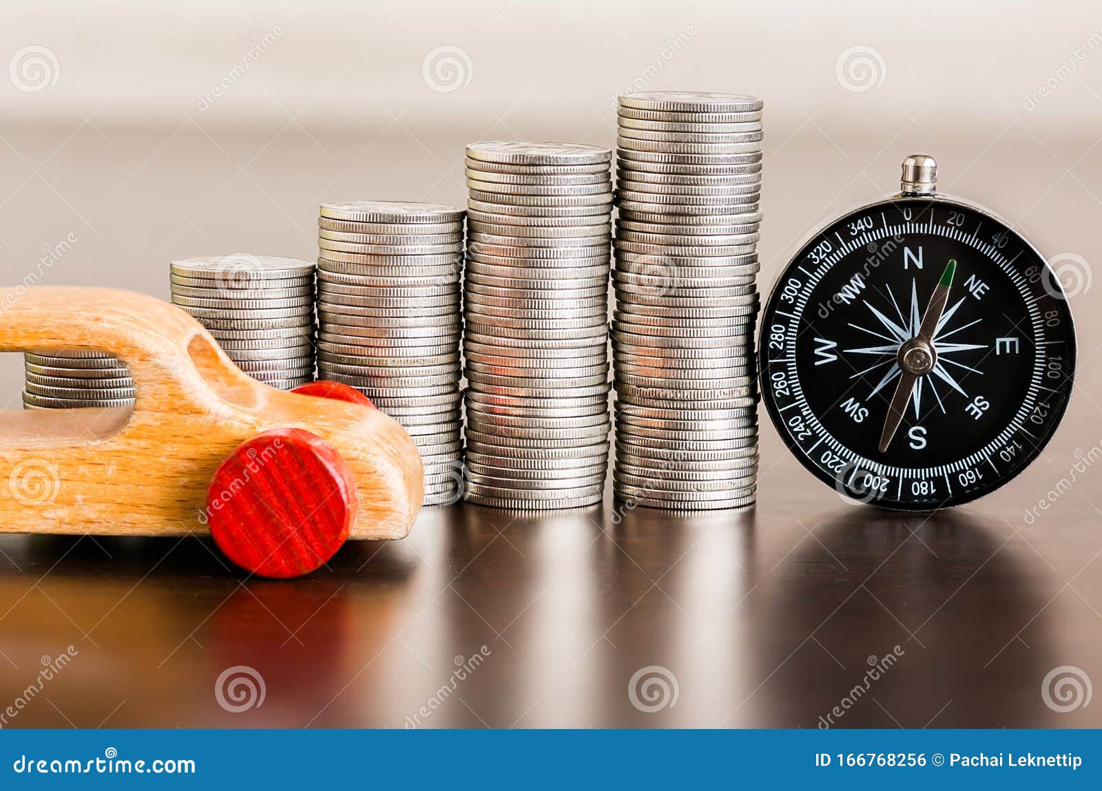 Stack of Coins with Compass and Wooden Car on Wood Table Stock Photo ...