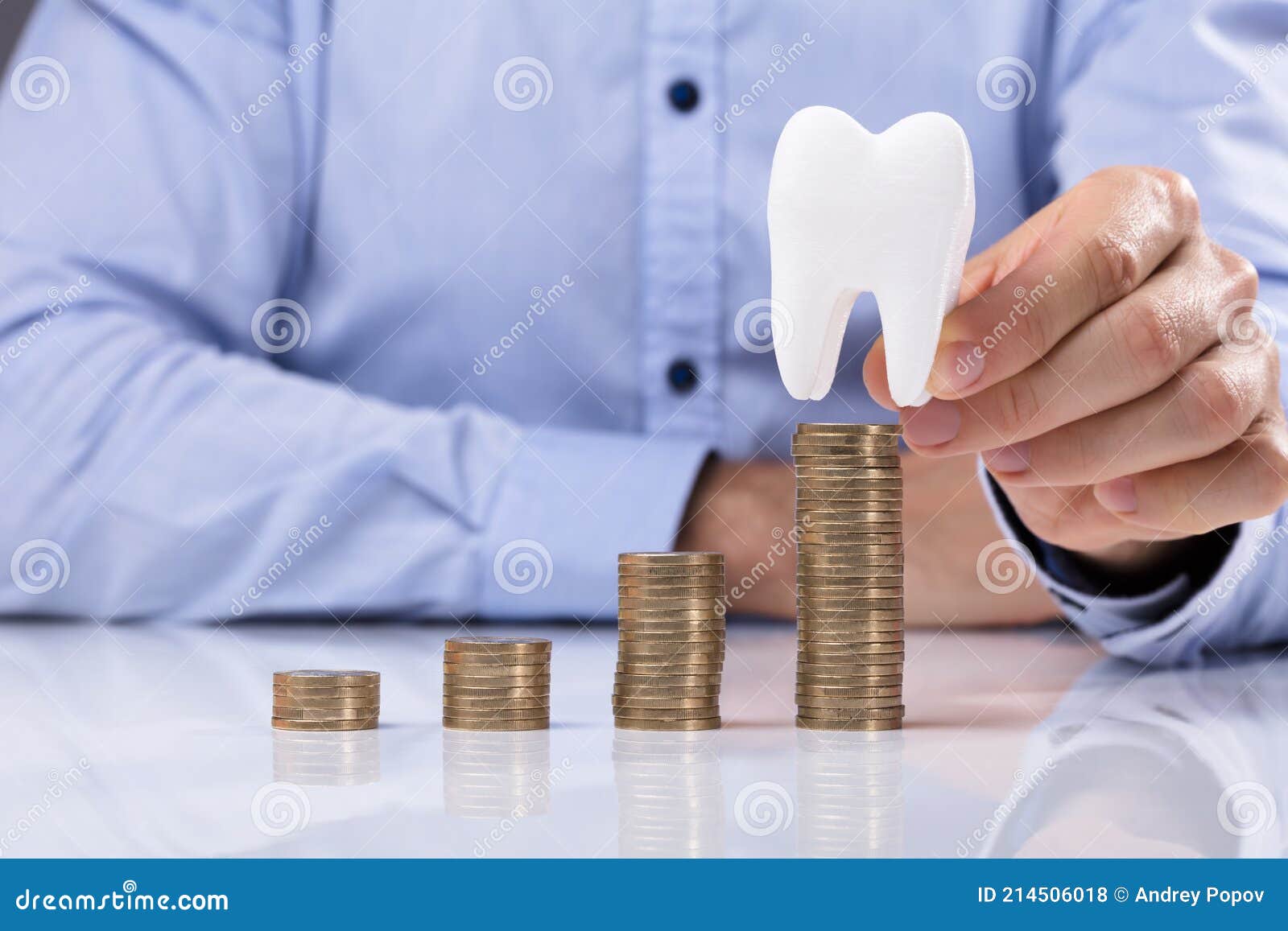 Stack of Coins in Front of Healthy Tooth Stock Photo - Image of hand ...