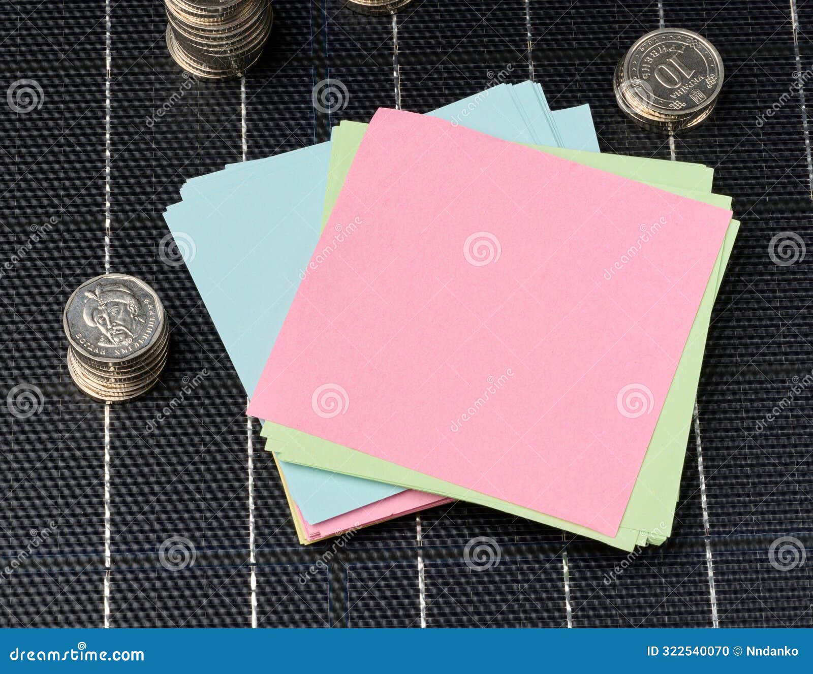 A Stack of Coins and Paper Stickers Stands on a Solar Panel, Budget ...