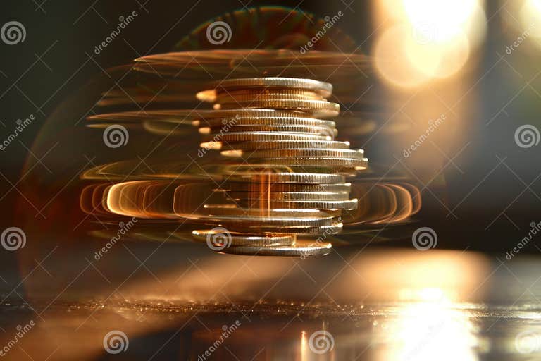 Stack of Coins Spinning and Creating Golden Light Trails Stock Image ...