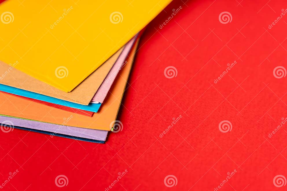 A Stack of Colored Envelopes on a Red Background Stock Photo - Image of ...