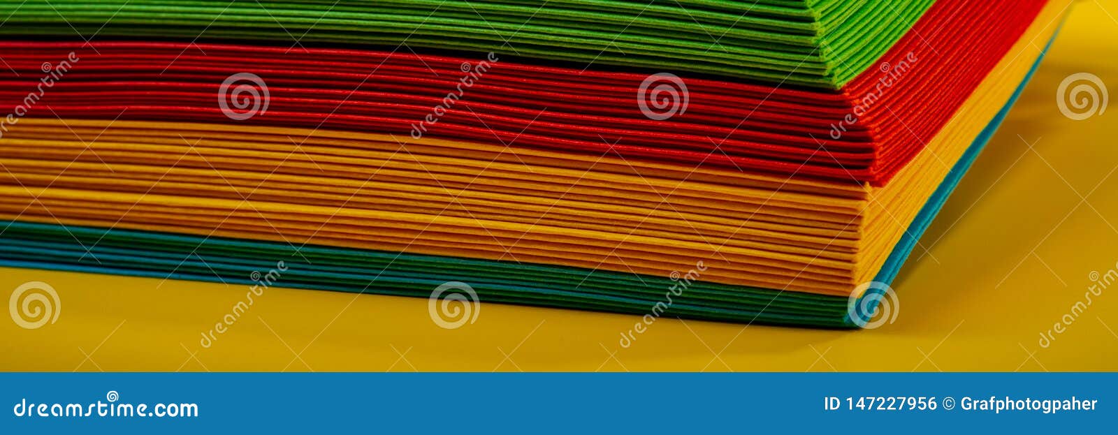 Stack of Colored Paper Envelopes on a Yellow Background Stock Photo ...