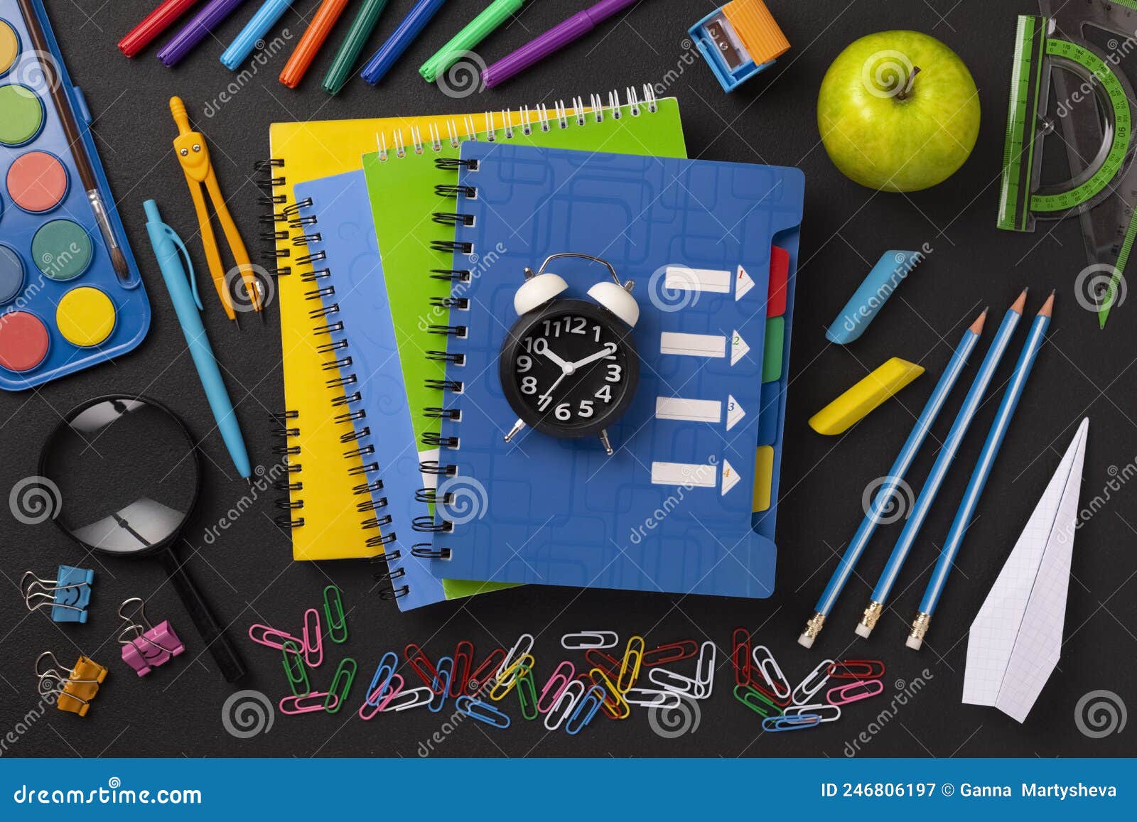 A Stack of Colored School Notebooks and an Alarm Clock on a School ...