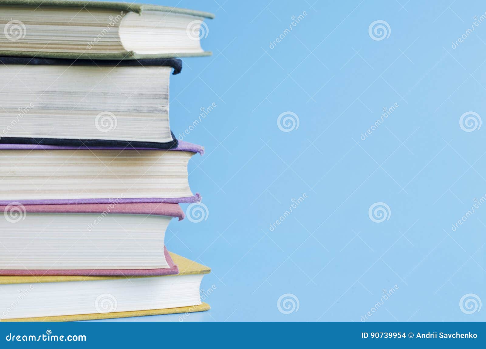 A Stack of Colorful Books on a Blue Background Stock Photo - Image of ...