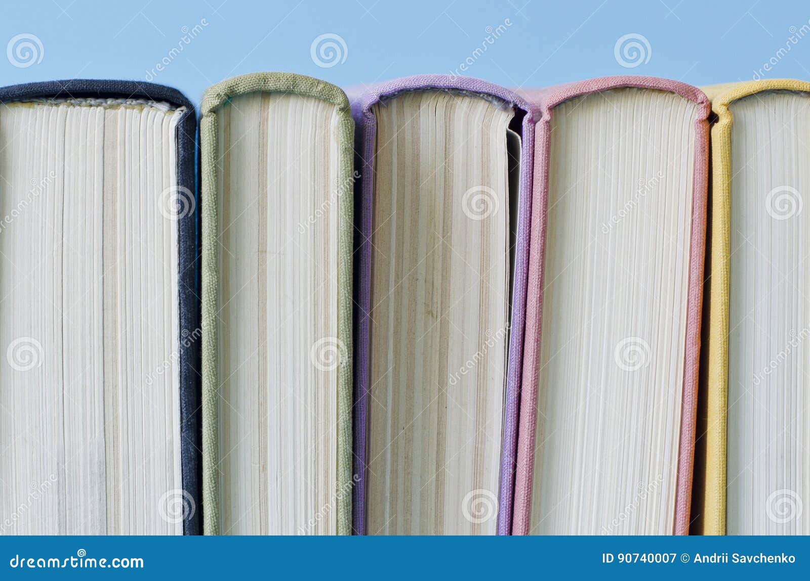 A Stack of Colorful Books on a Blue Background Stock Image - Image of ...