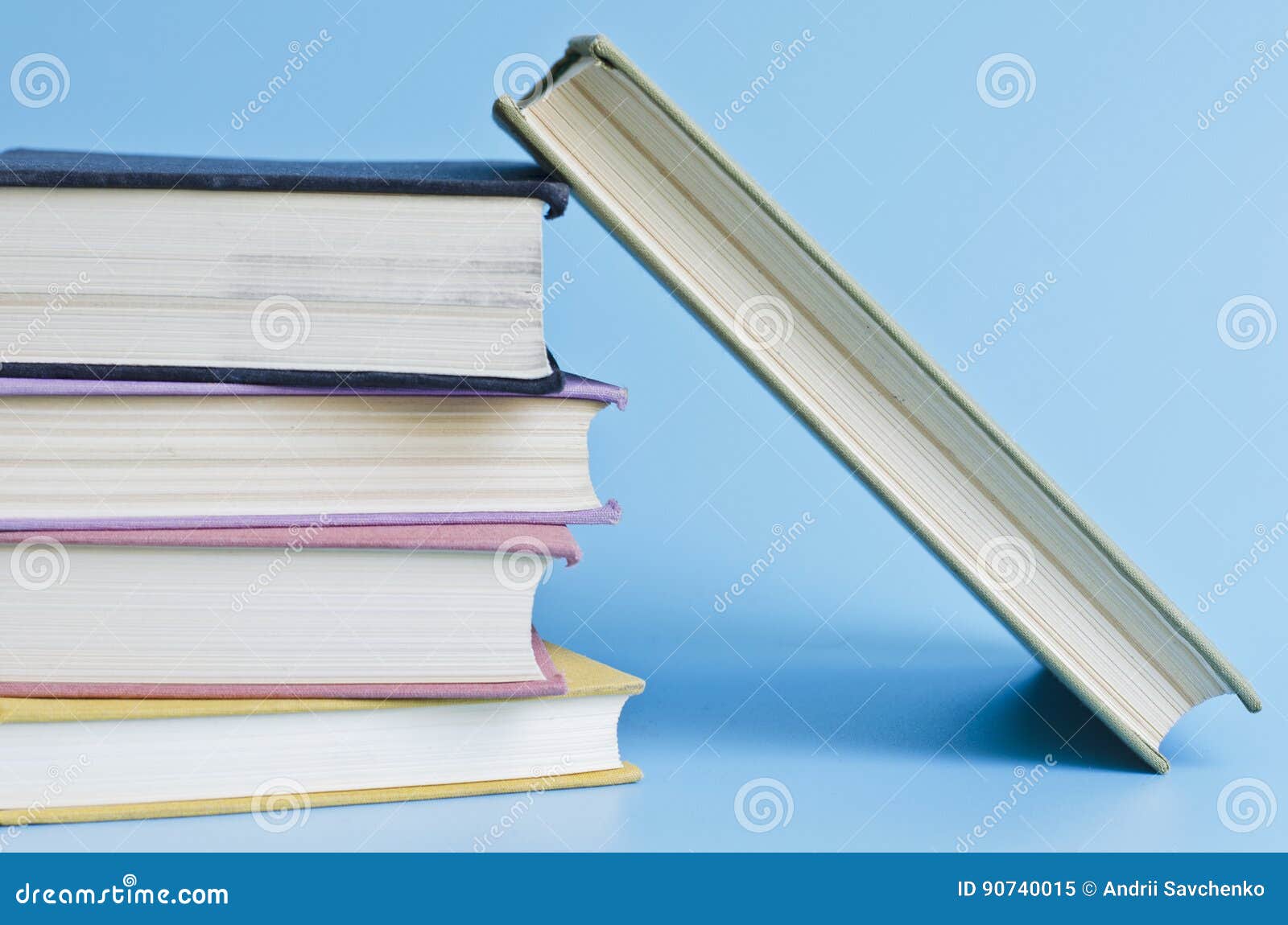 A Stack of Colorful Books on a Blue Background Stock Image - Image of ...