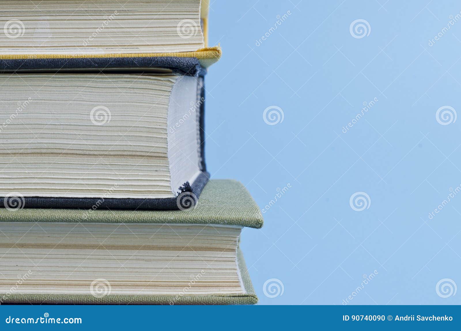 A Stack of Colorful Books on a Blue Background Stock Photo - Image of ...