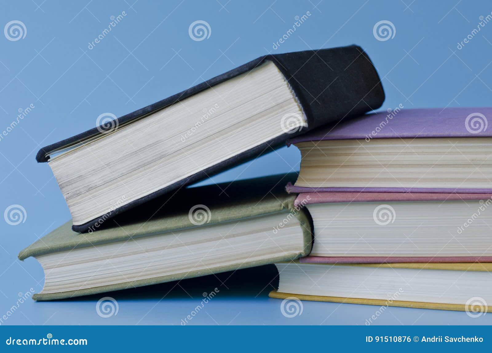 A Stack of Colorful Books on a Blue Background Stock Photo - Image of ...