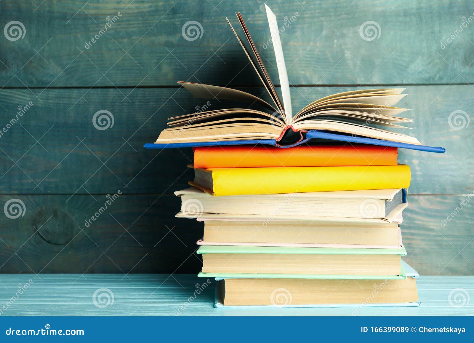 Stack of Colorful Books on Light Blue Table Stock Image - Image of ...