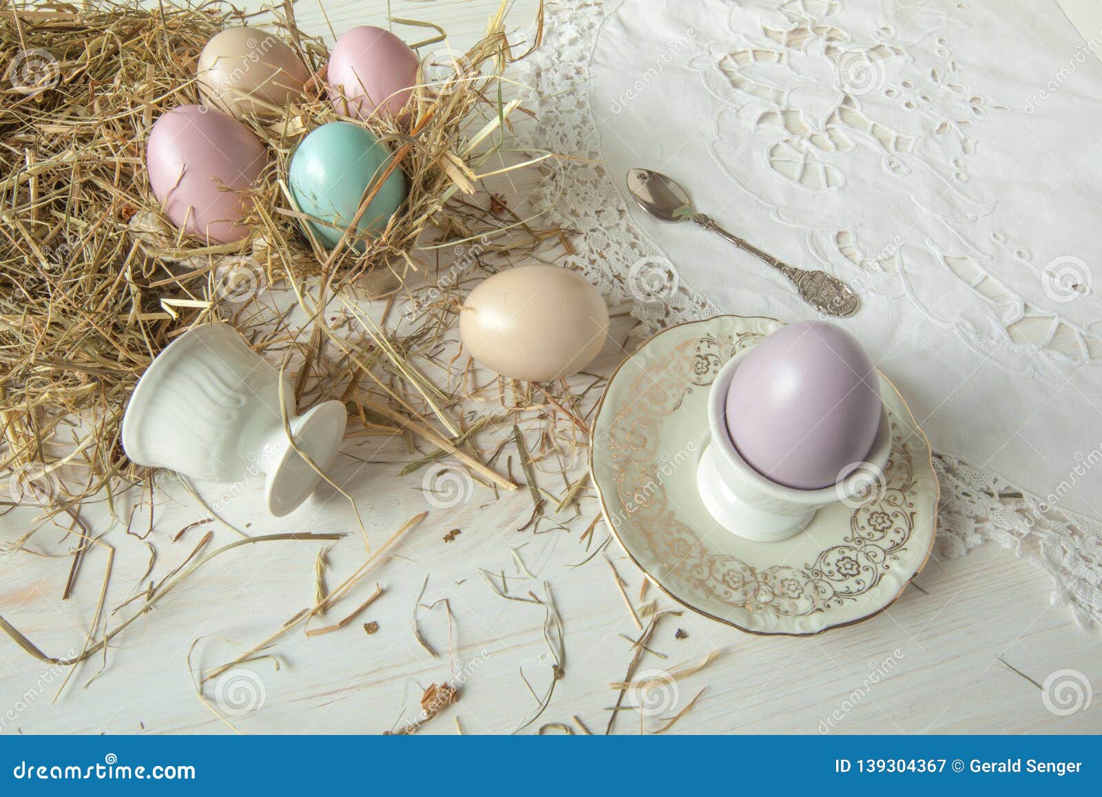 Stack of Colorful Easter Eggs on Straw with Wooden Table Background ...
