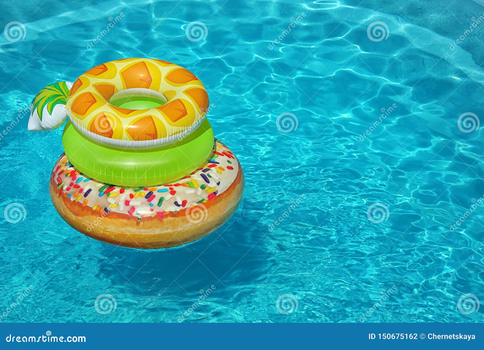 Stack of Colorful Inflatable Rings Floating in Swimming Pool on Sunny ...