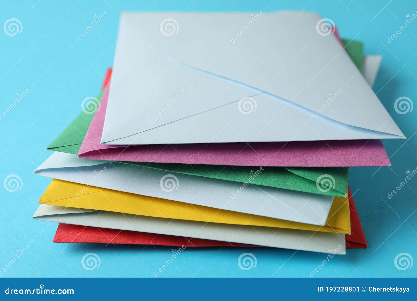 Stack of Colorful Paper Envelopes on Light Blue Background, Closeup ...