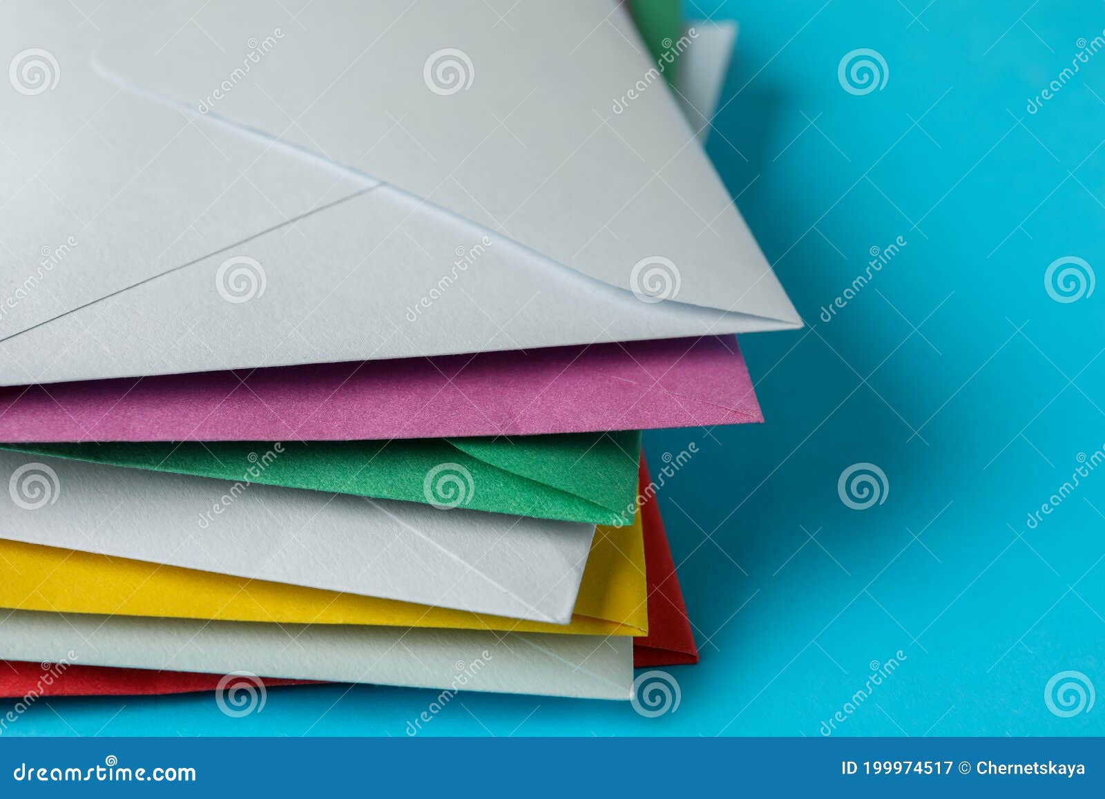 Stack of Colorful Paper Envelopes on Light Blue Background, Closeup ...